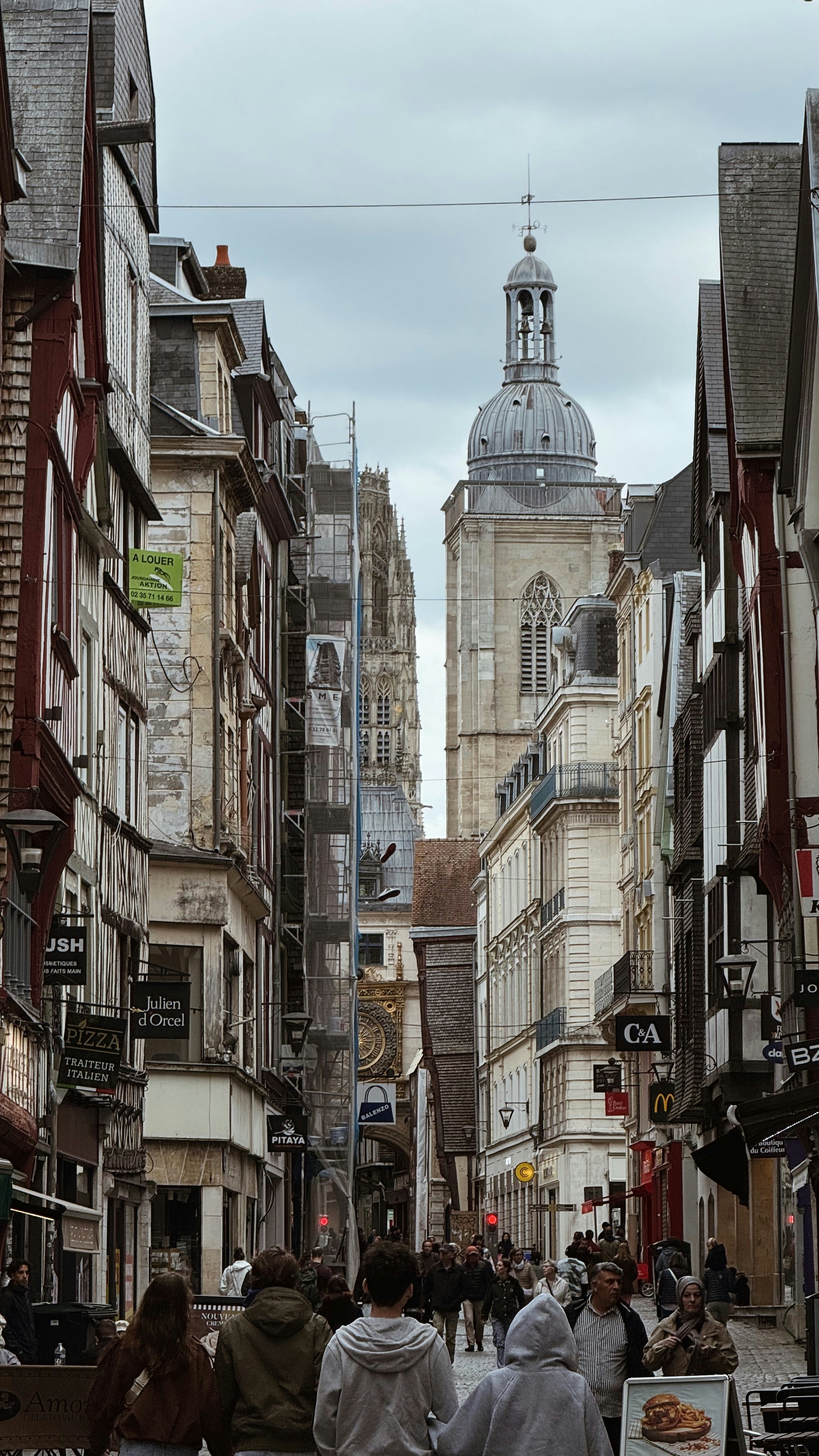 Cathedral Spire Over a Quiet Street of Stone and Signboards