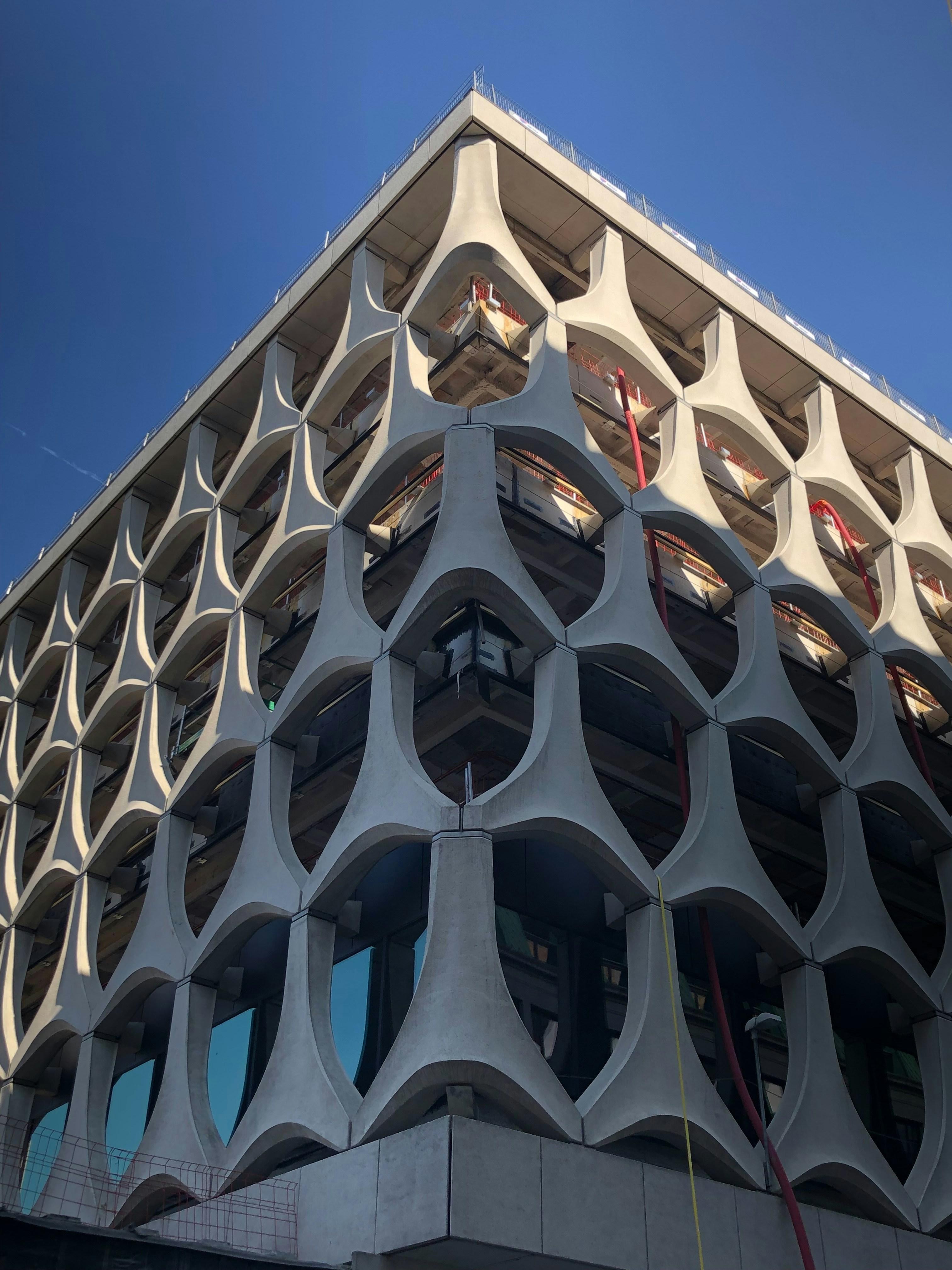 Honeycomb Facade: Gravity-Defying Lattice on a Modernist Building