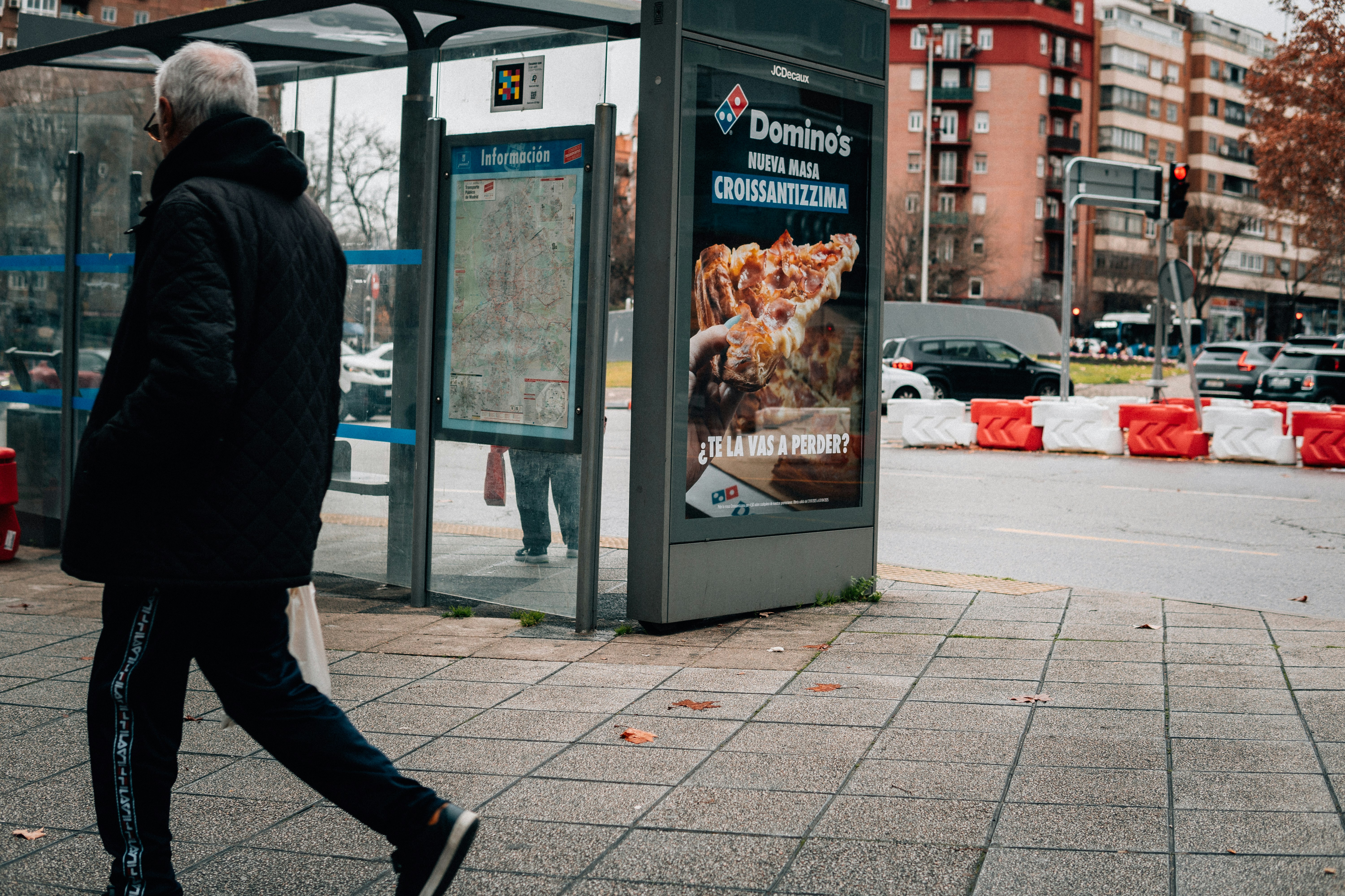 City Bus Stop Silhouette: A Leaning Walk in the Street