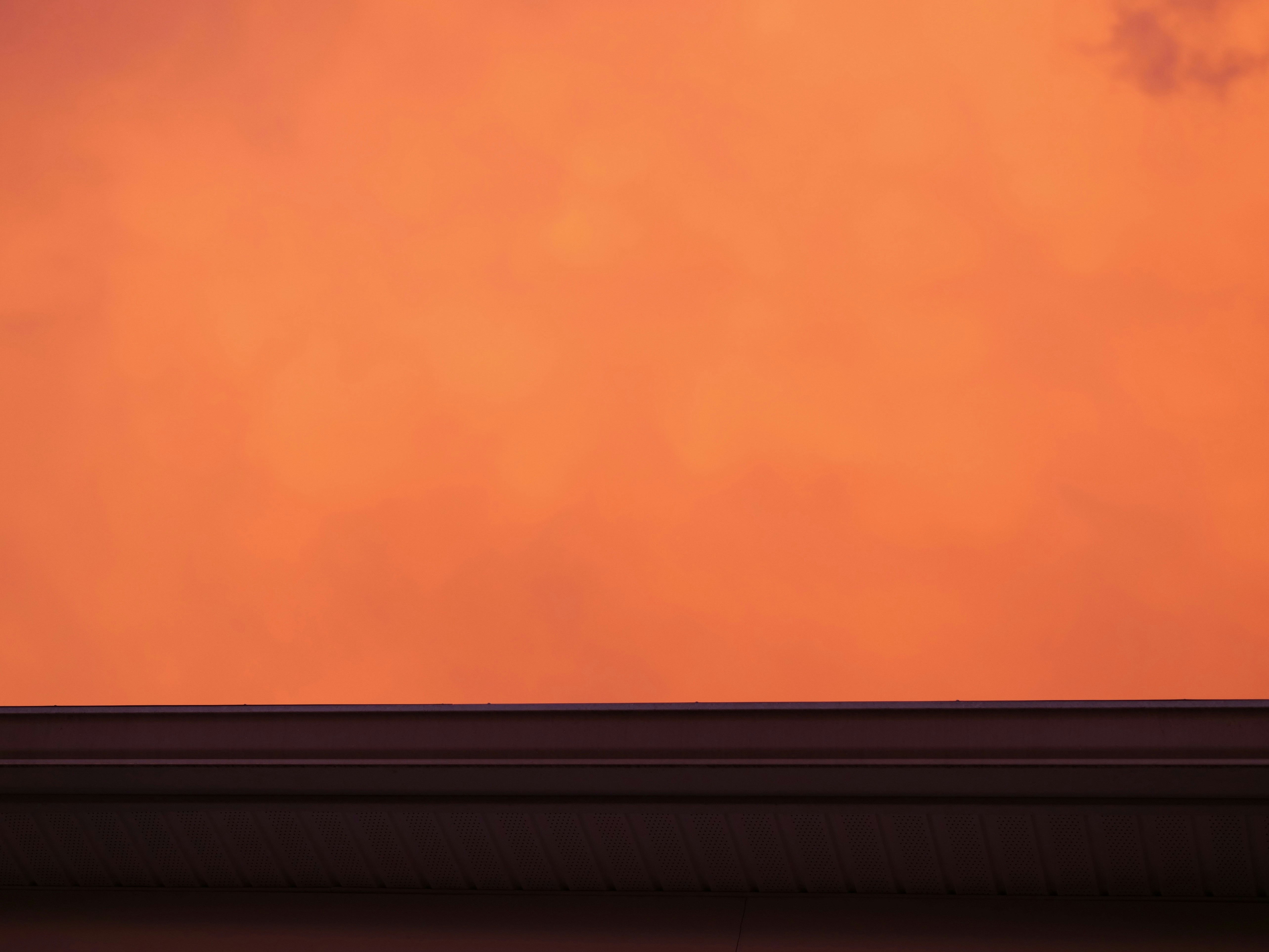 Orange Sky over a Minimal Roof Silhouette