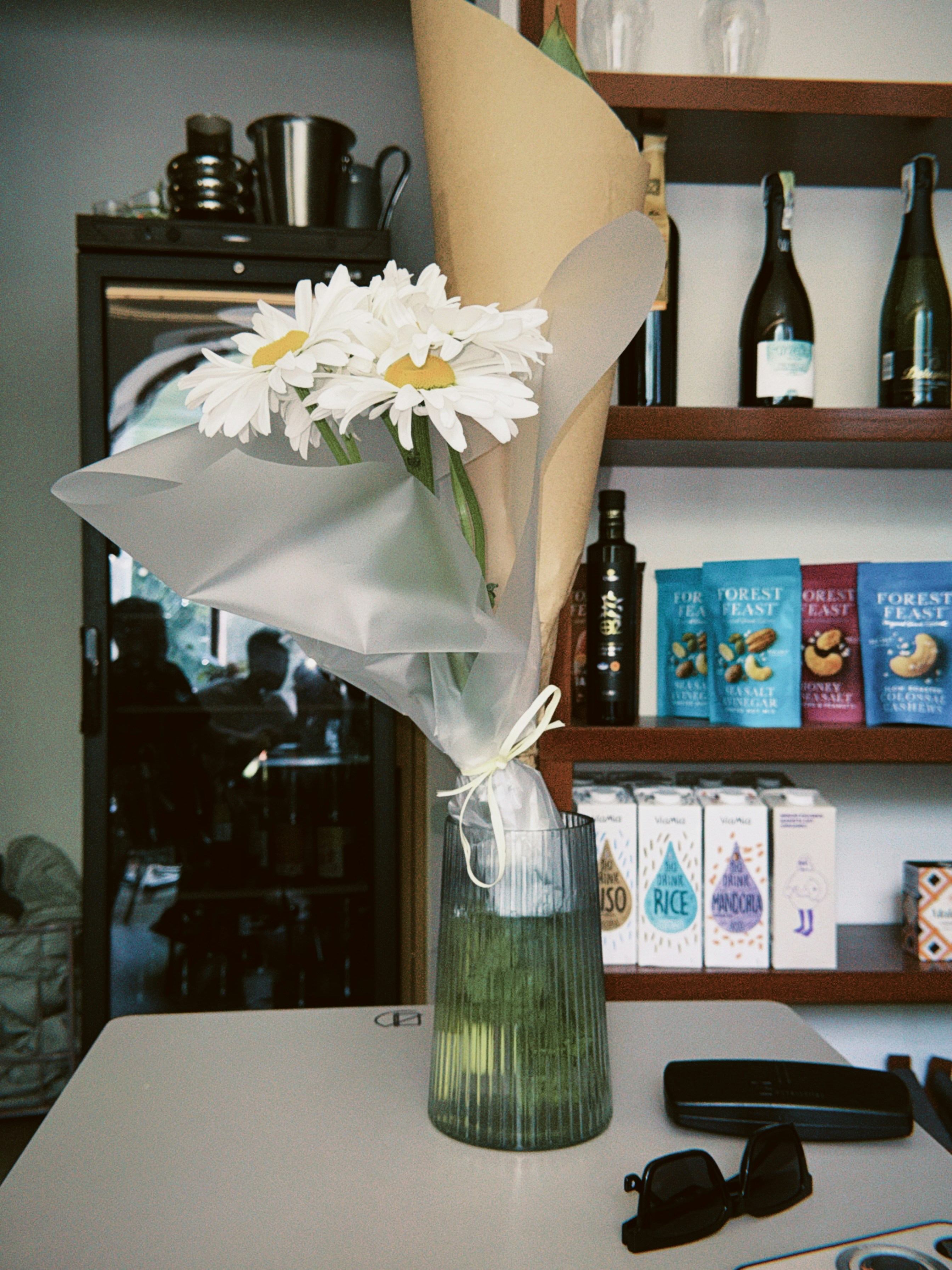 Bouquet in a To-Go Vase: Still Life Beneath Shelves of Taste