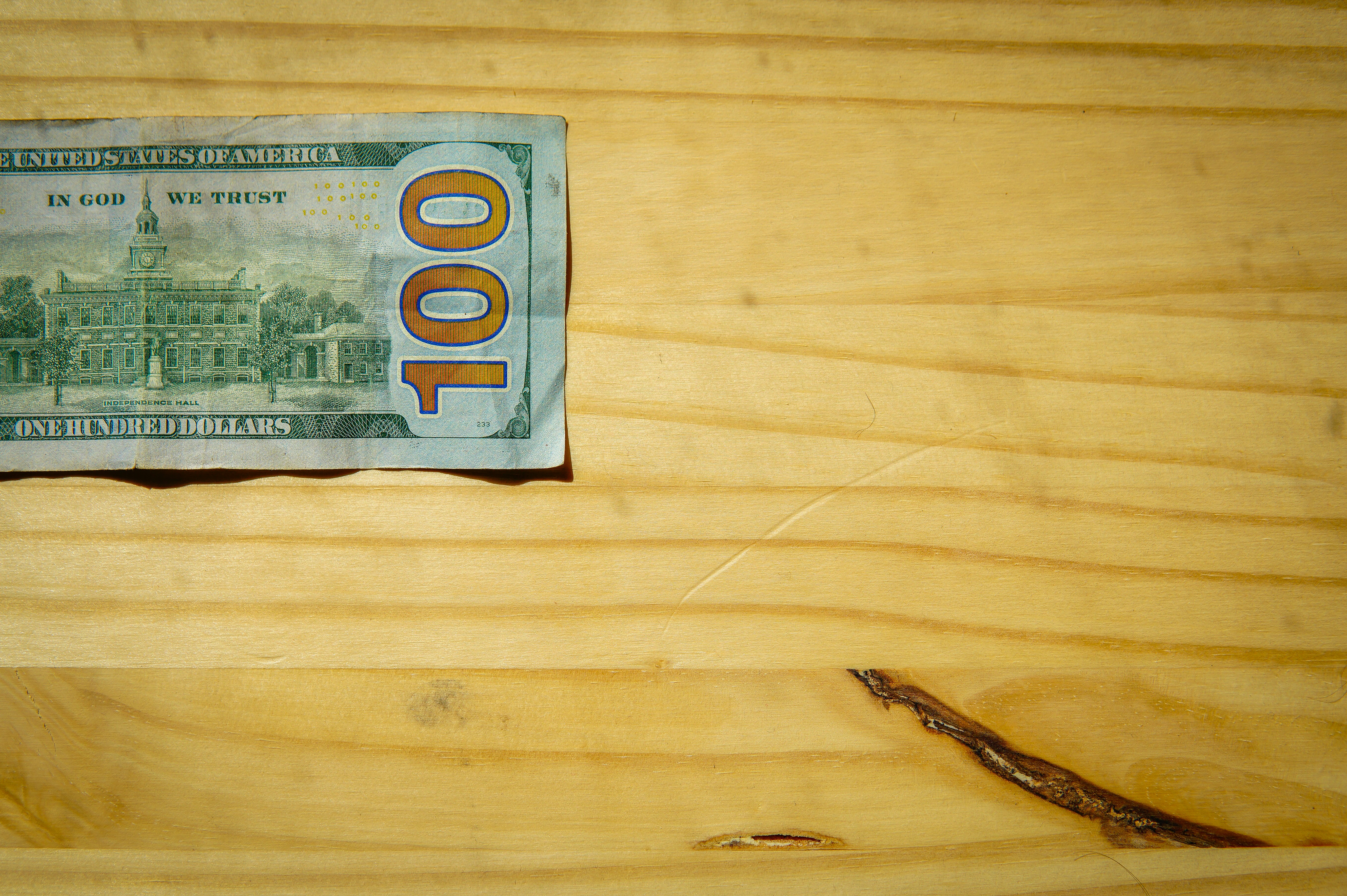 A Tattered Hundred: Dollar Leaf on a Wooden Table