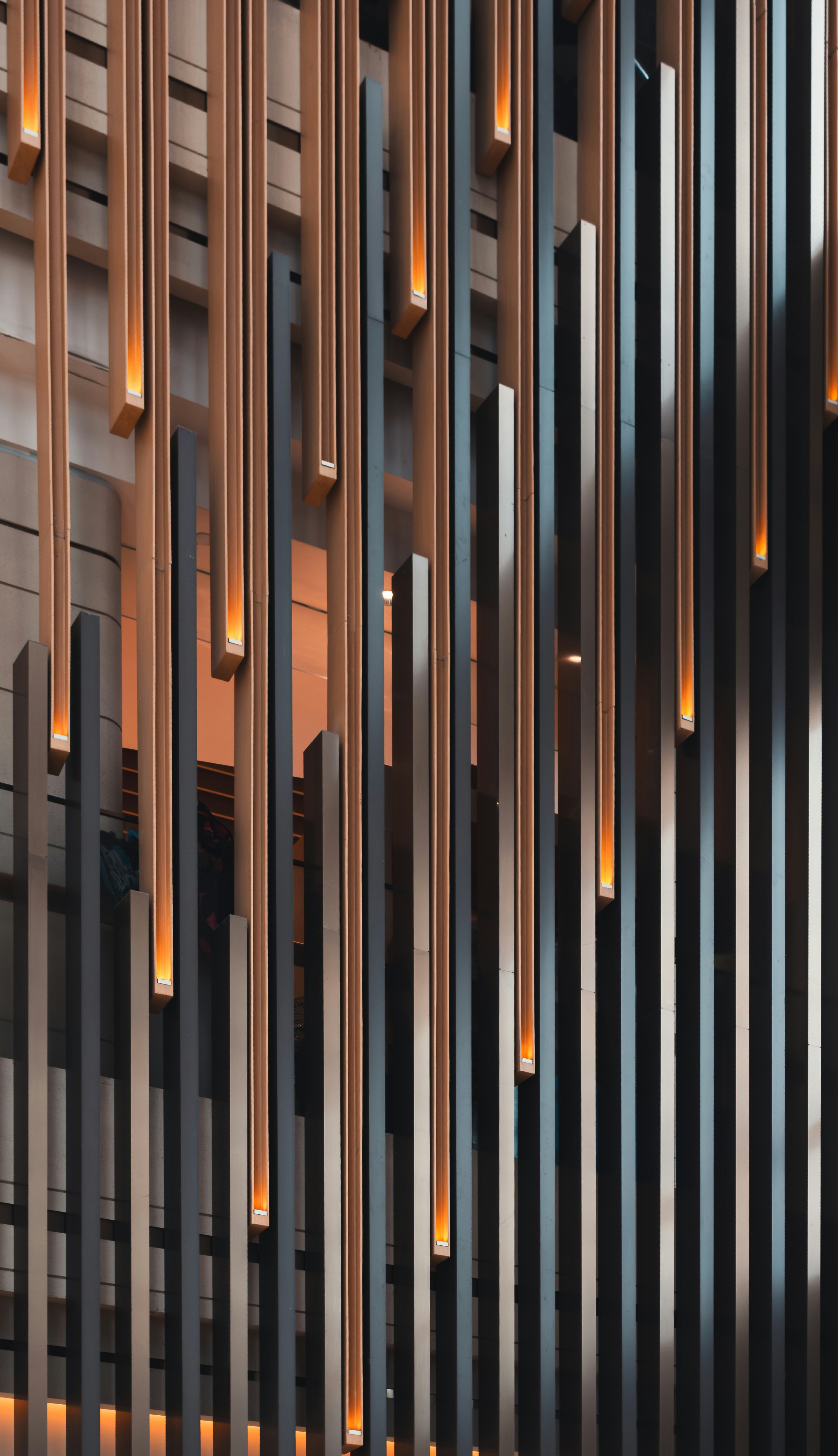 Vertical Warmth: A Field of Bronze Slats with Firelit Edges