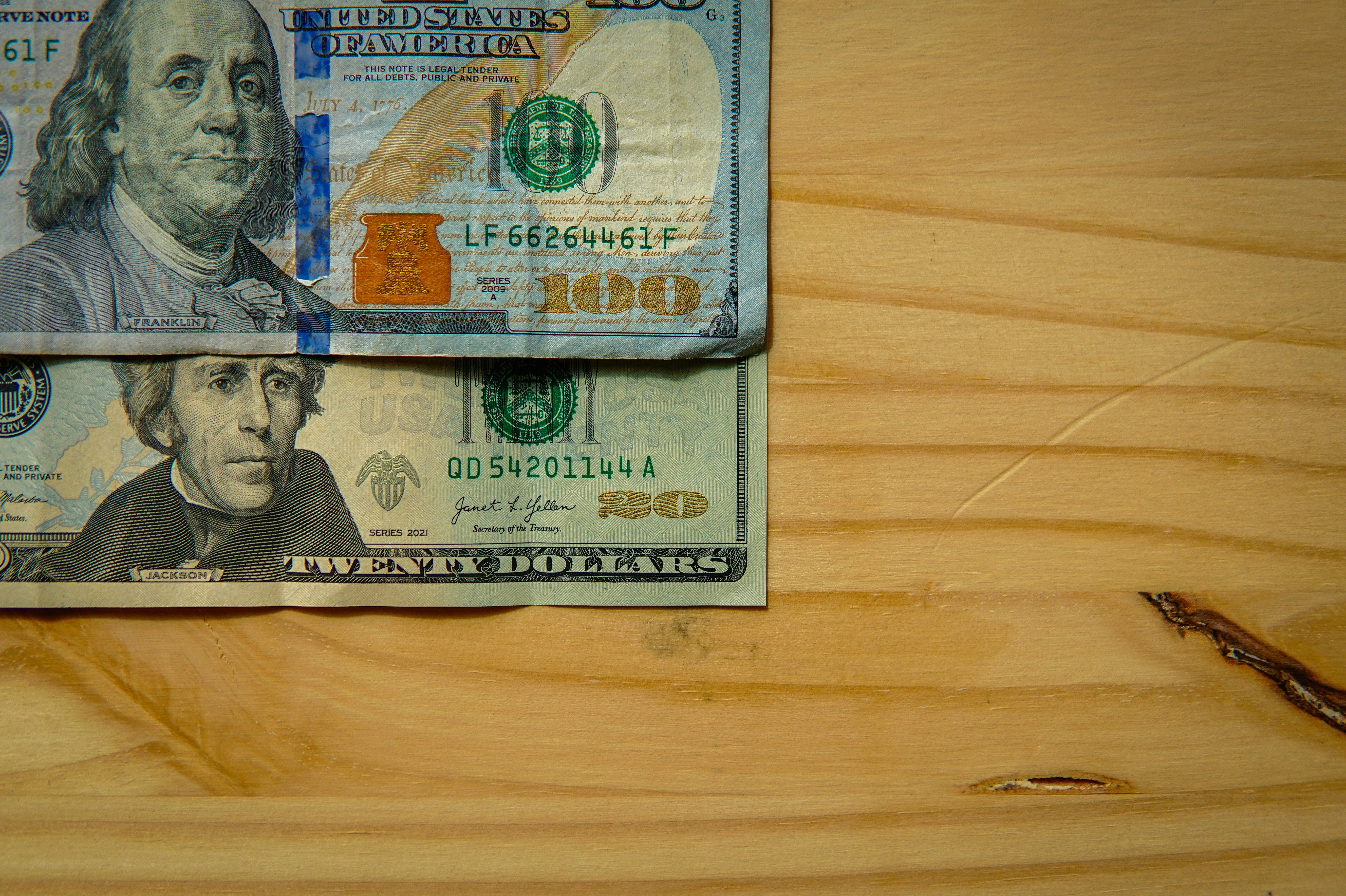 Folded Cash on a Warm Wooden Surface