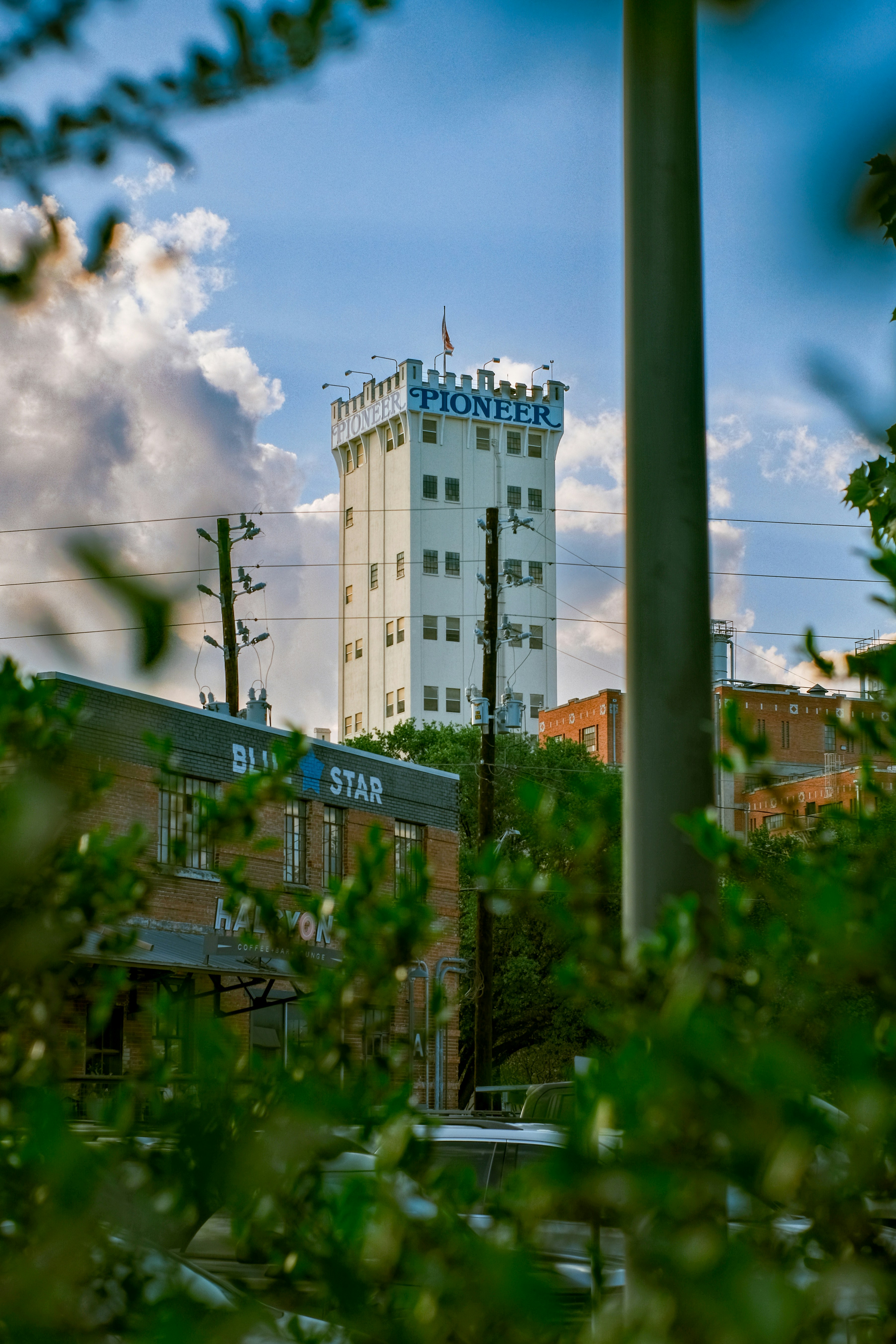Pioneer Tower Rising Above a Green-Framed City Street
