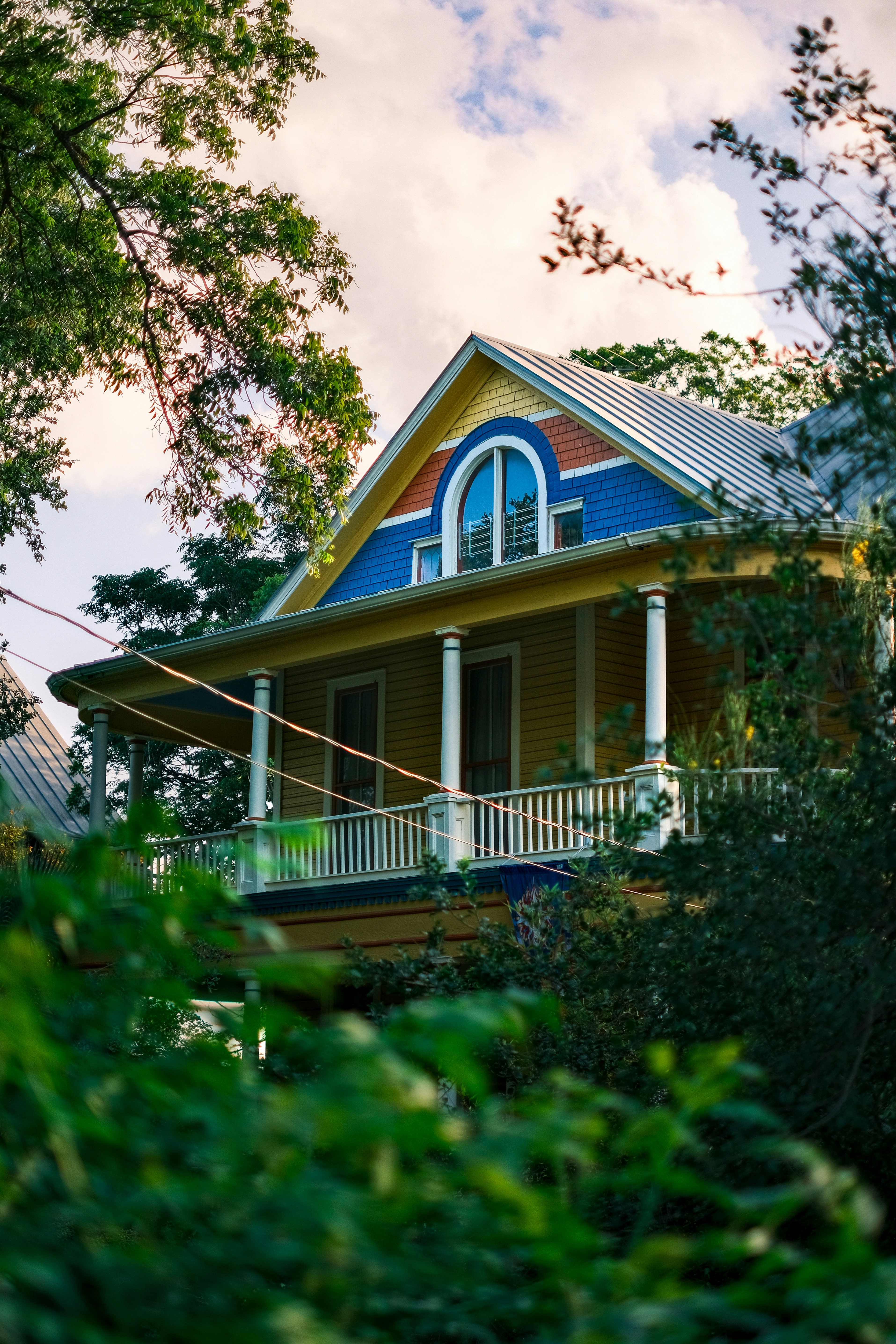 Colorful Gable House Peeking Through Greenery