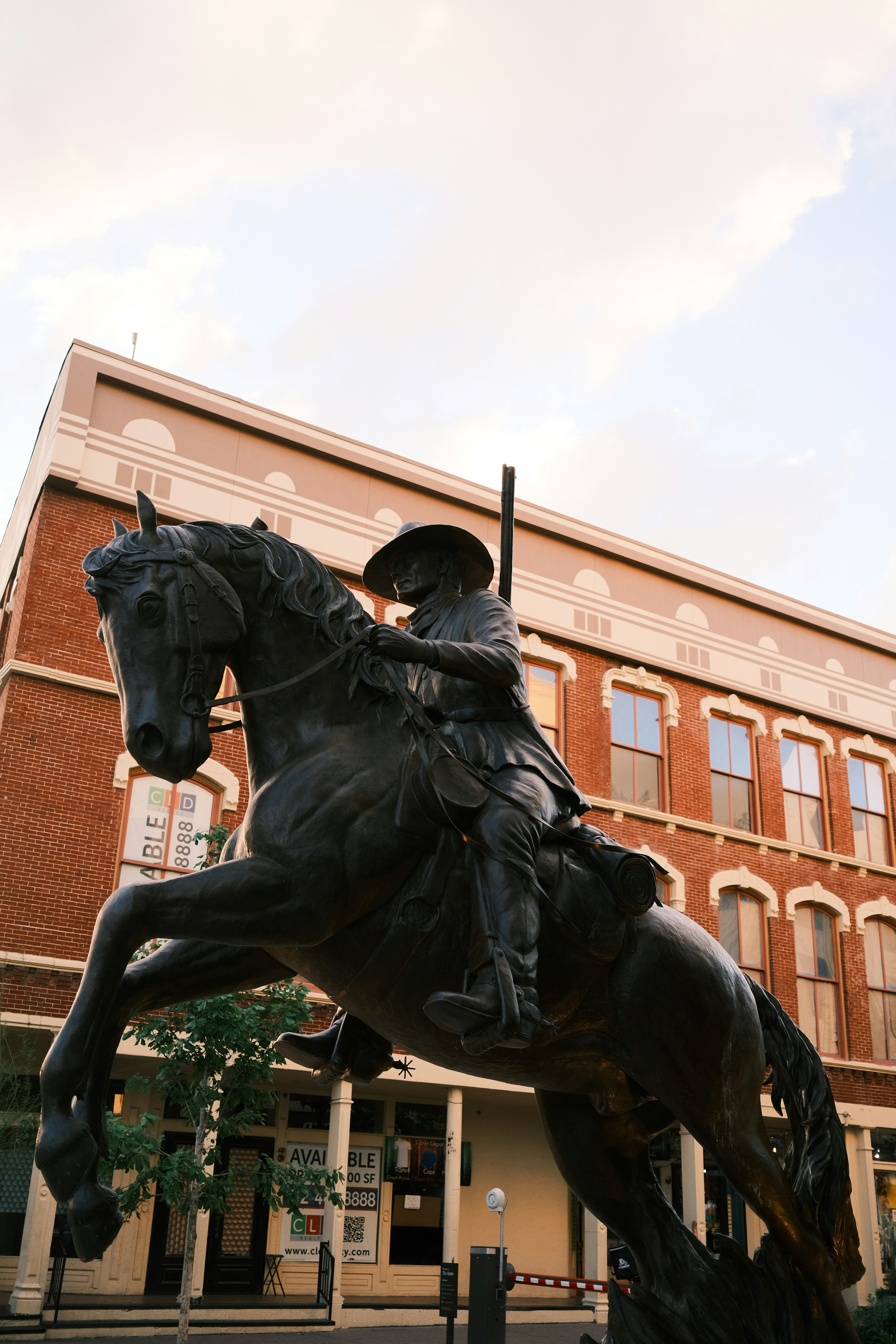 Equestrian Sentinel: A Bronze Rider Against a Brick Clockwork