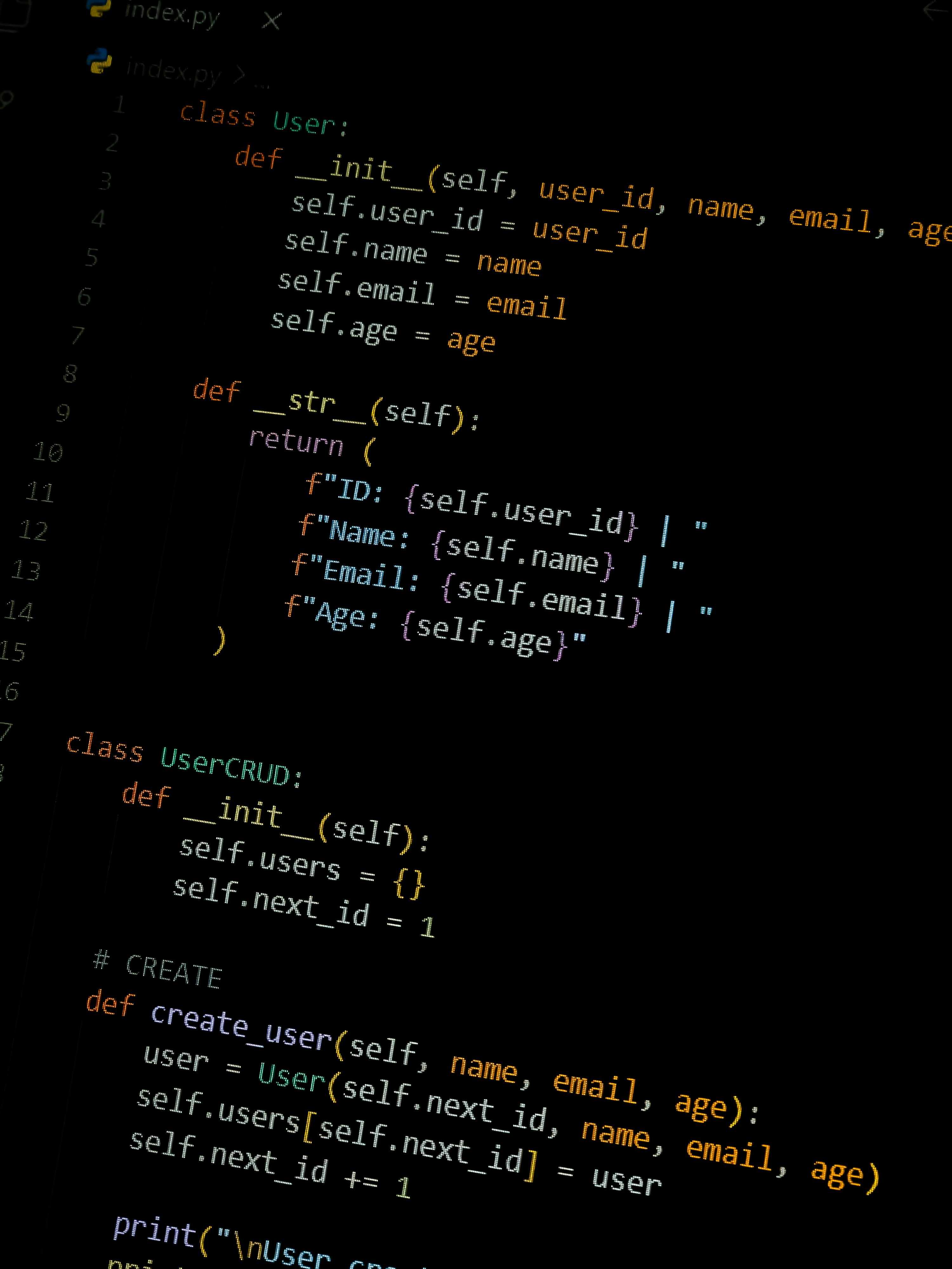 Code editor glow illuminates a shadowy screen with Python-like class definitions and functions. Logo-like syntax highlighting hints at a software project in progress.