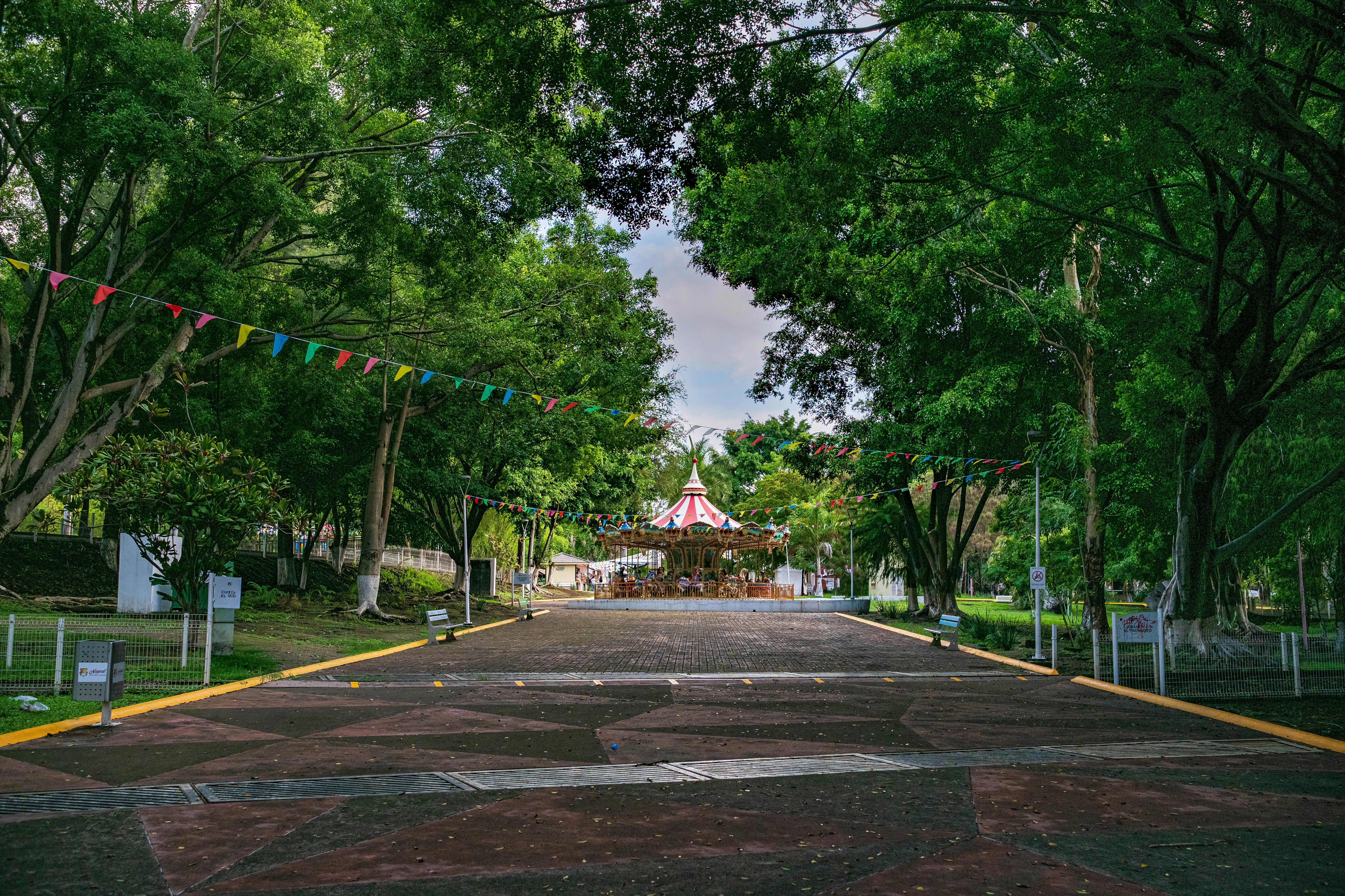 Festooned Park Avenue: Colorful Flags Framing a Quiet Carousel