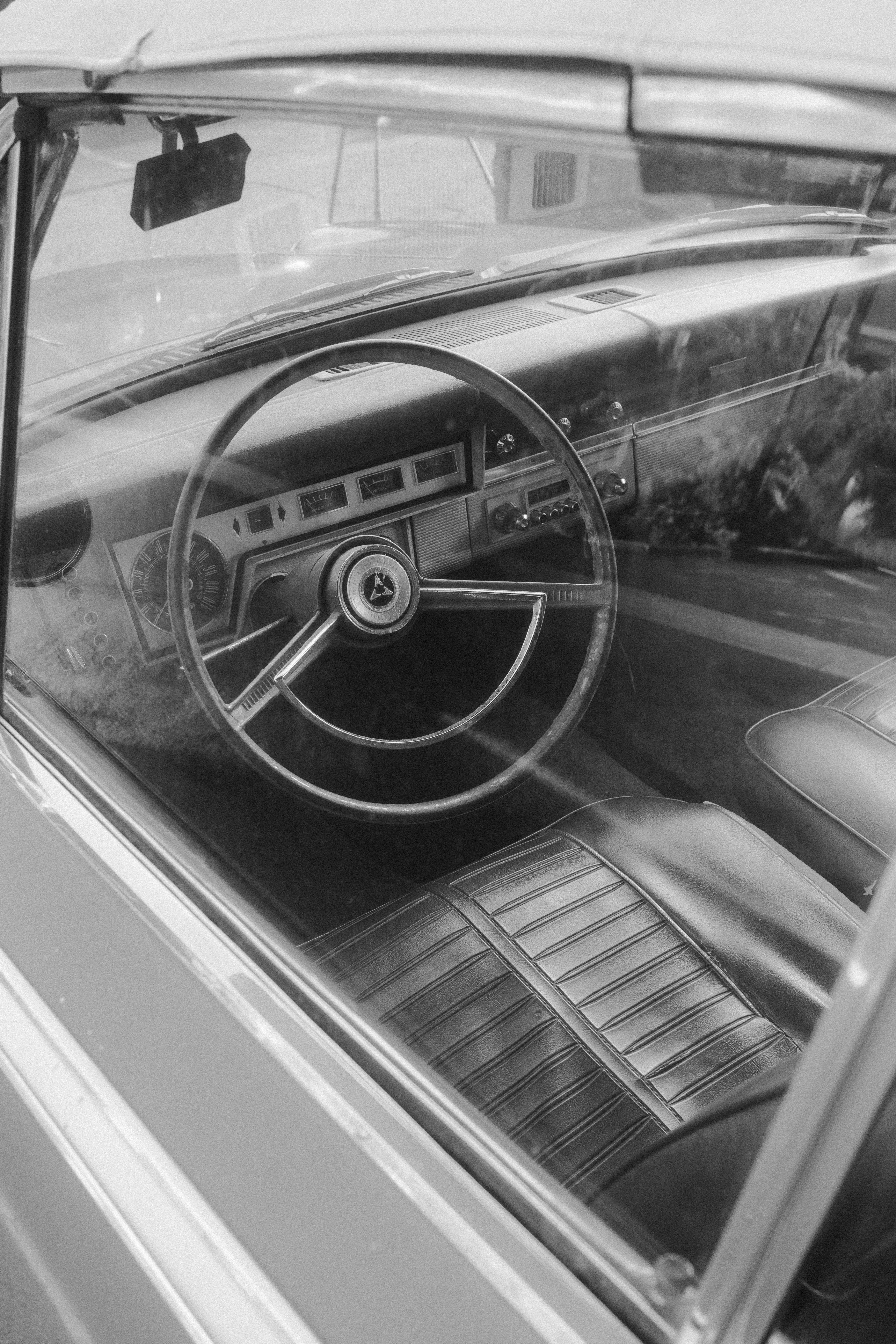 Black and white view of a vintage car's interior.