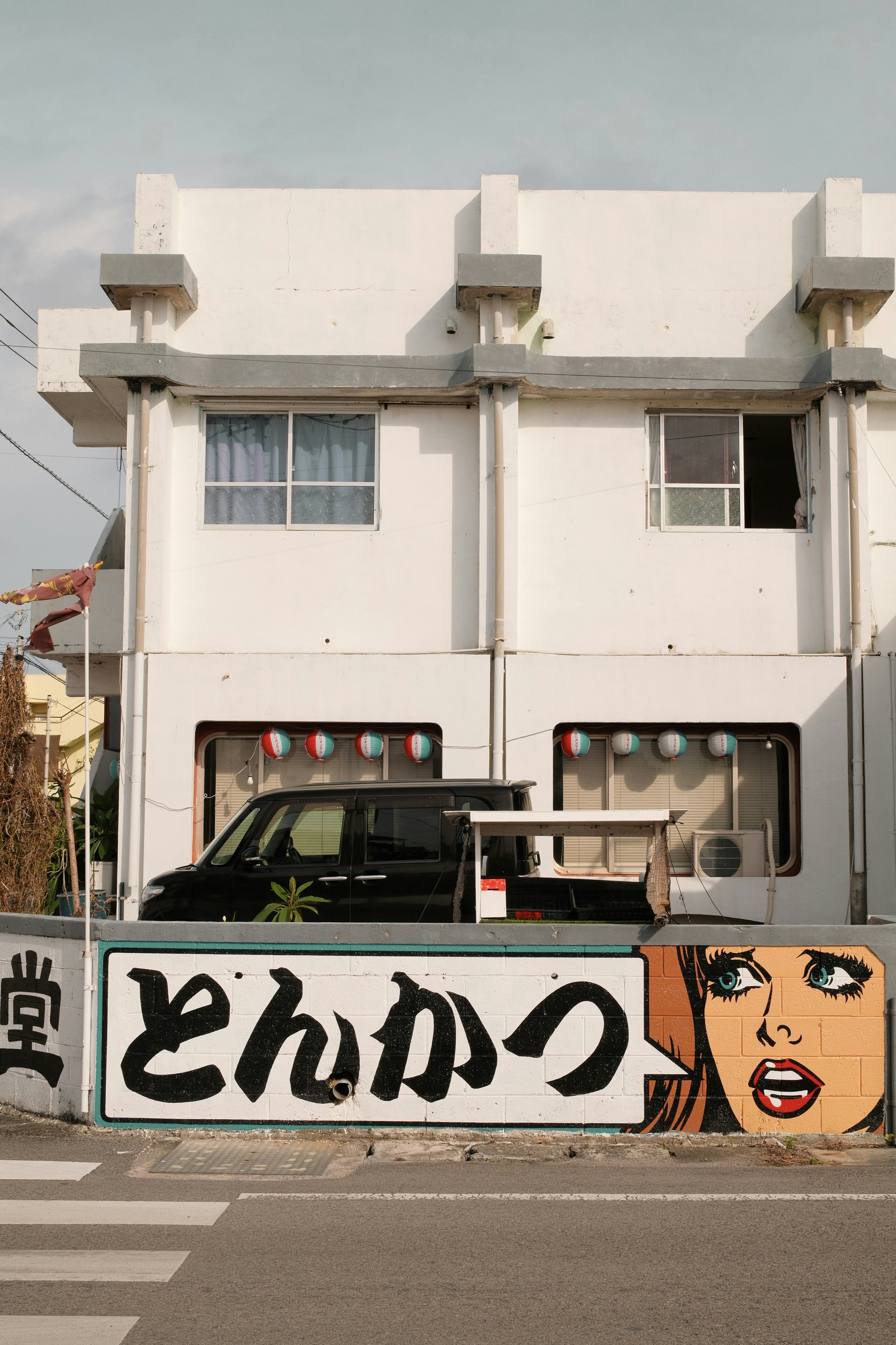 Comic Wall and Balcony Car: Urban Scene with a Black Van under a Pop-Art Panel