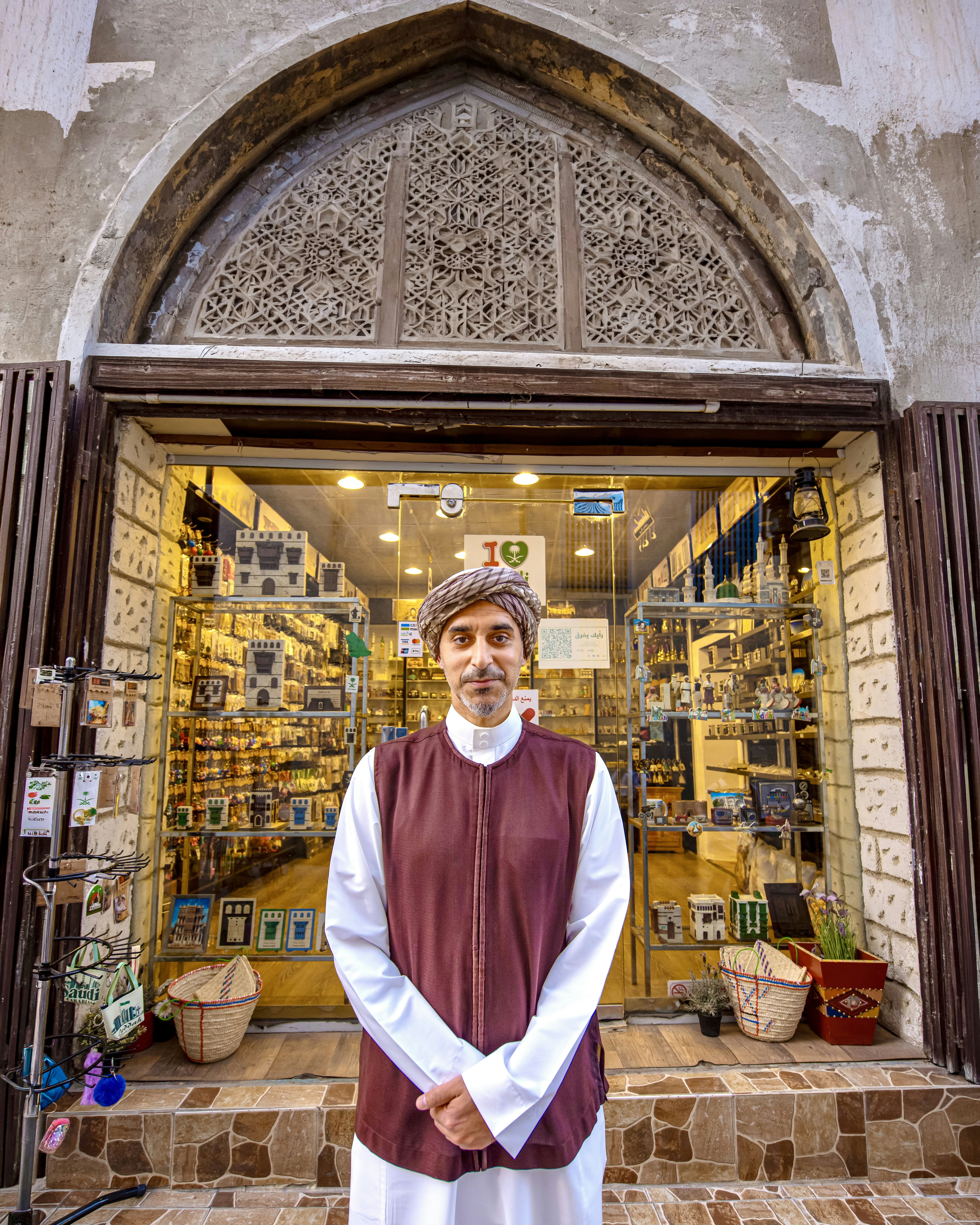 Heritage merchant at the archway: a doorway into a color-saturated marketplace