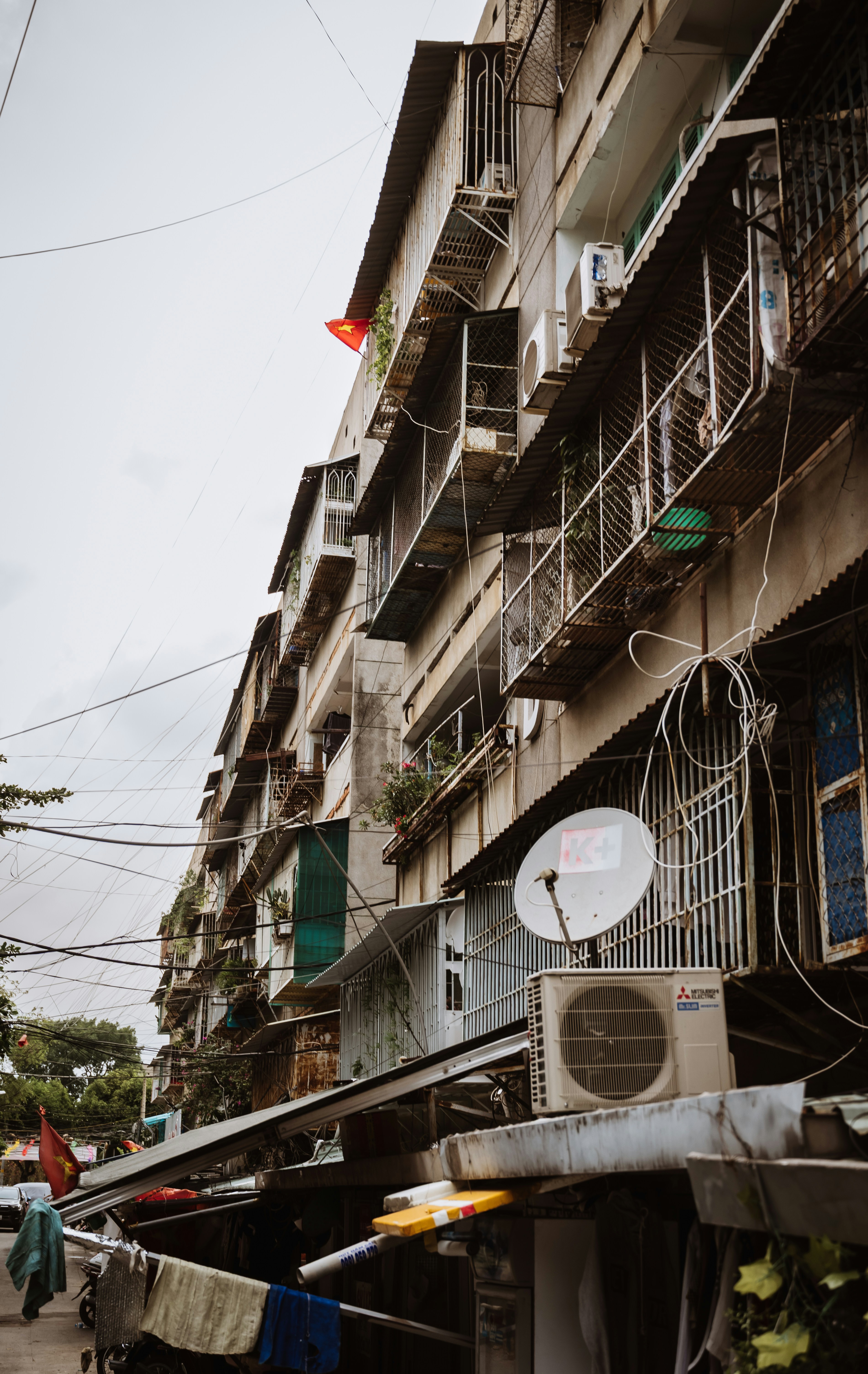 Cluttered Balcony Corridor: Wiring, Air Conditioning, and Laundry