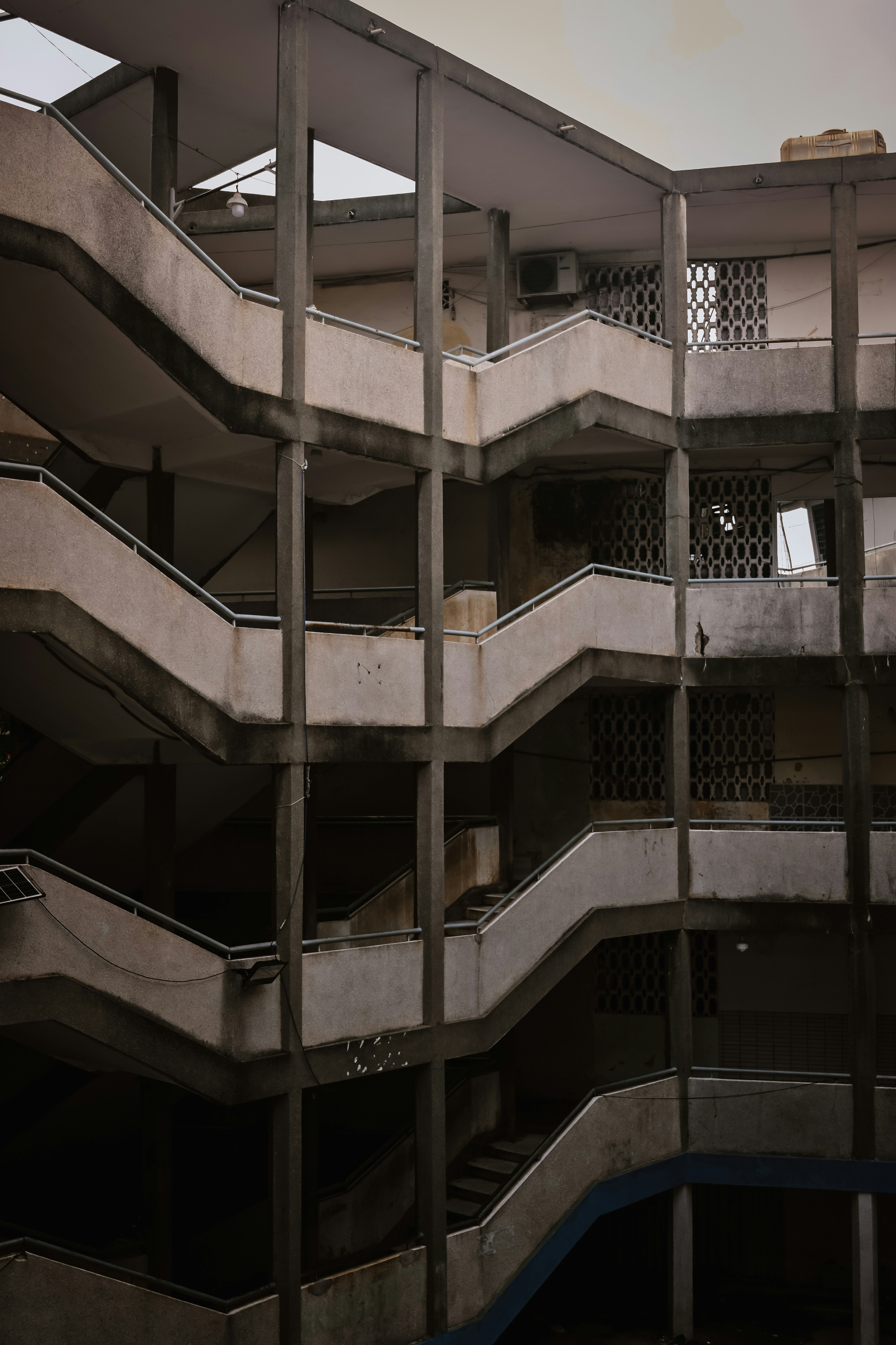 Concrete Atrium Echoes: Staircases Weave Through Shadows
