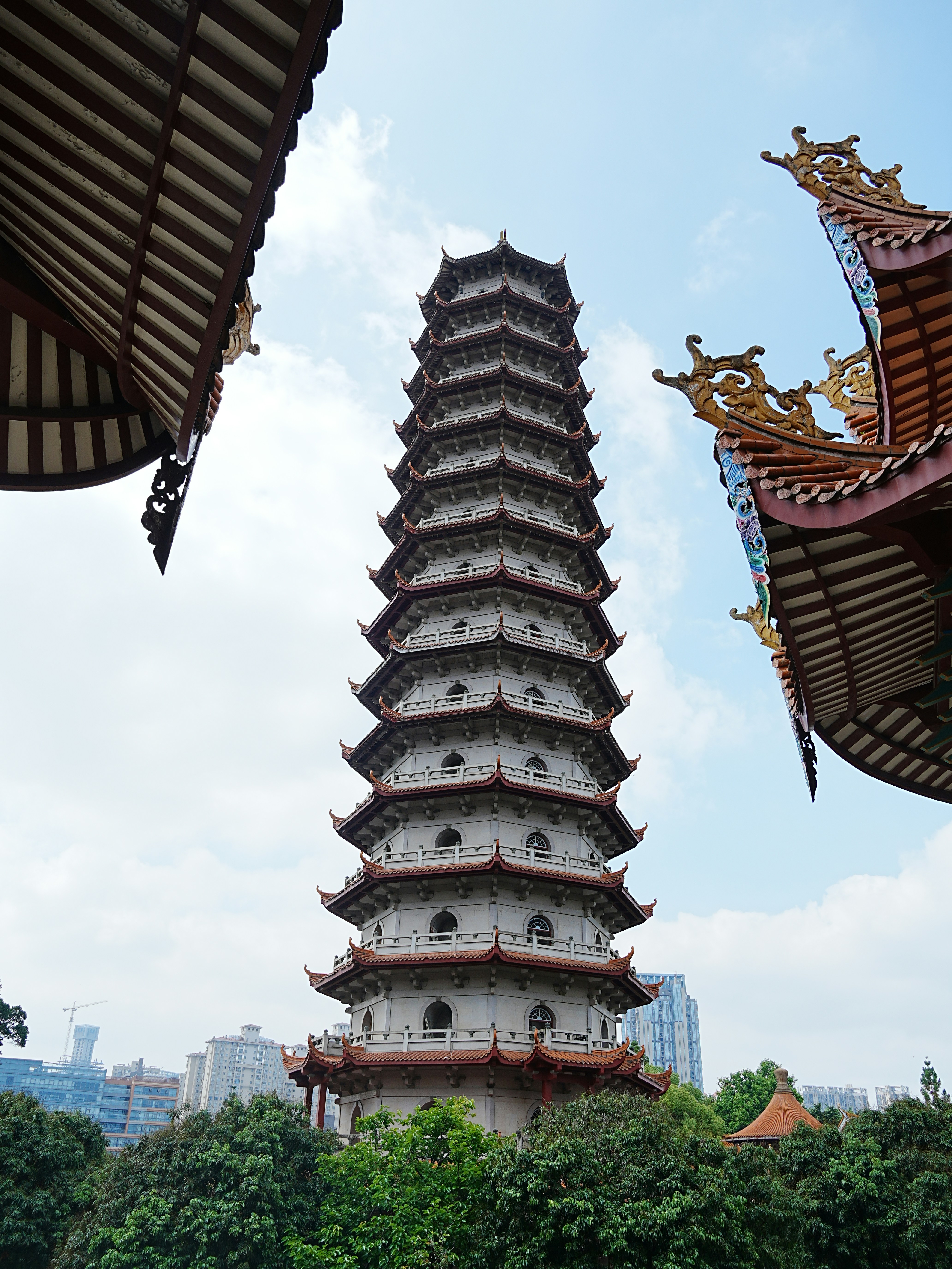 Central Pagoda Ascending: A Towering Spire Between Temple Rooflines