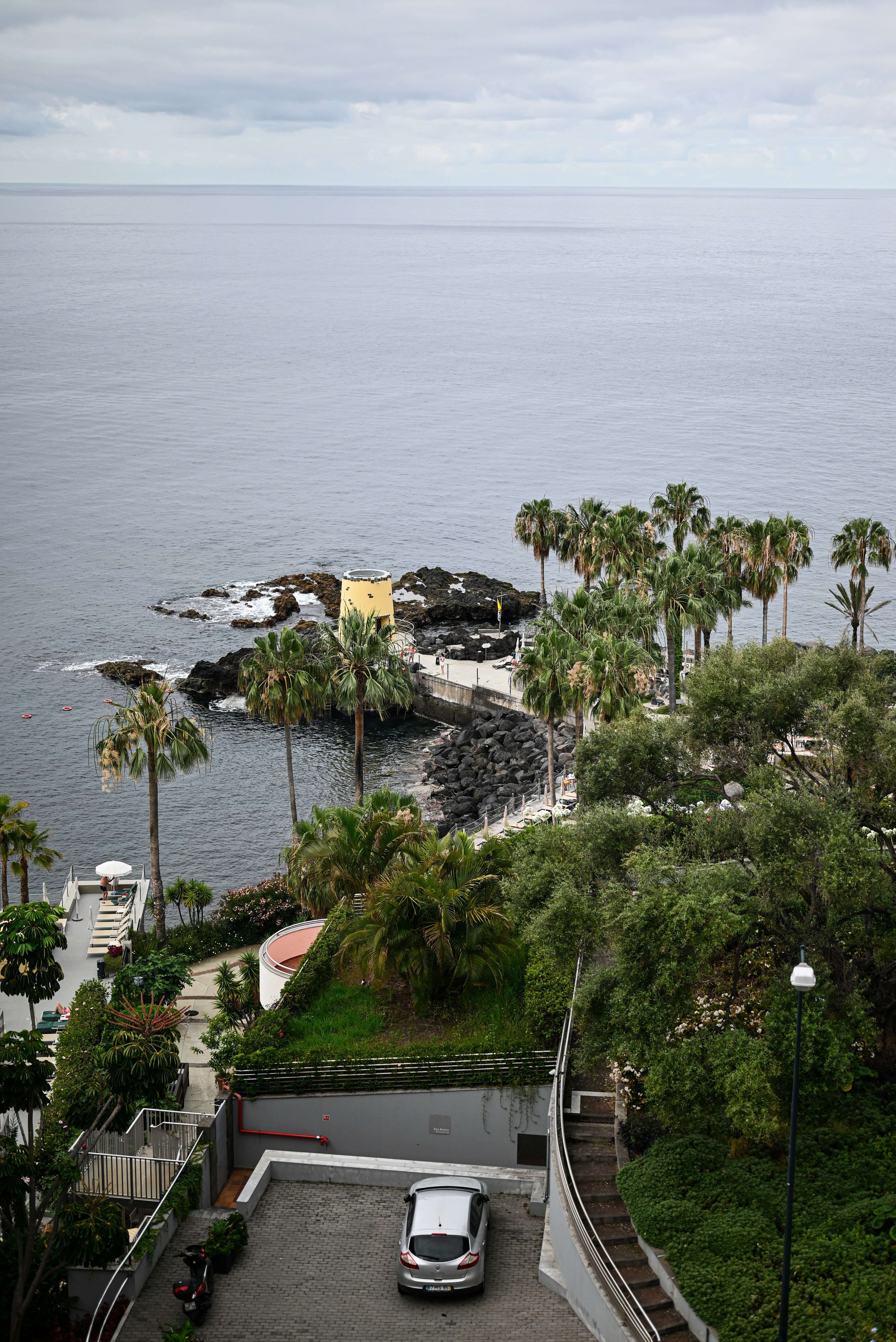 Oceanfront Terrace with Palm Oasis above a winding stair and car court