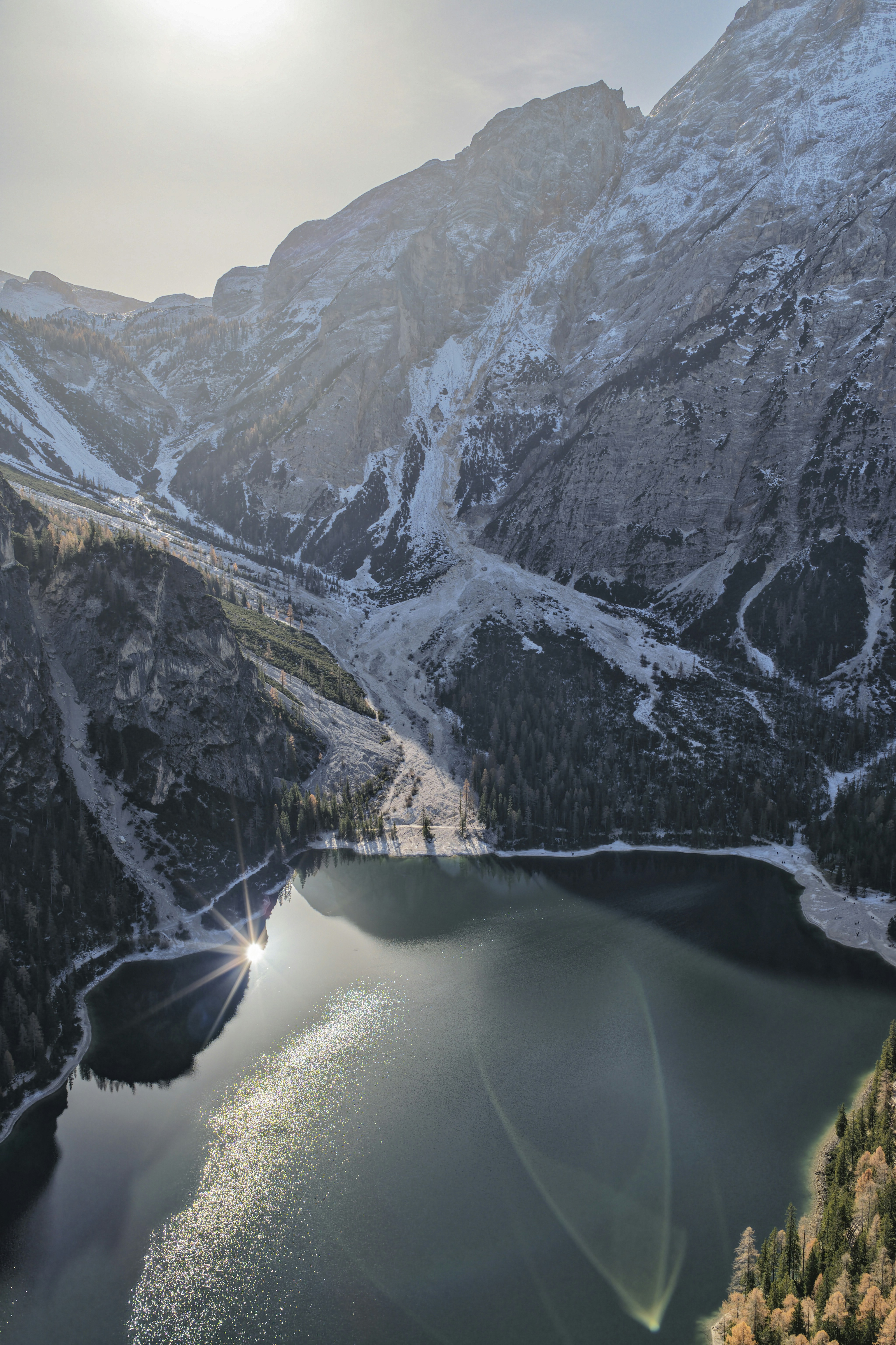 Glacial Mirror: Sunlit Lake in a Cradled Alpine Gorge