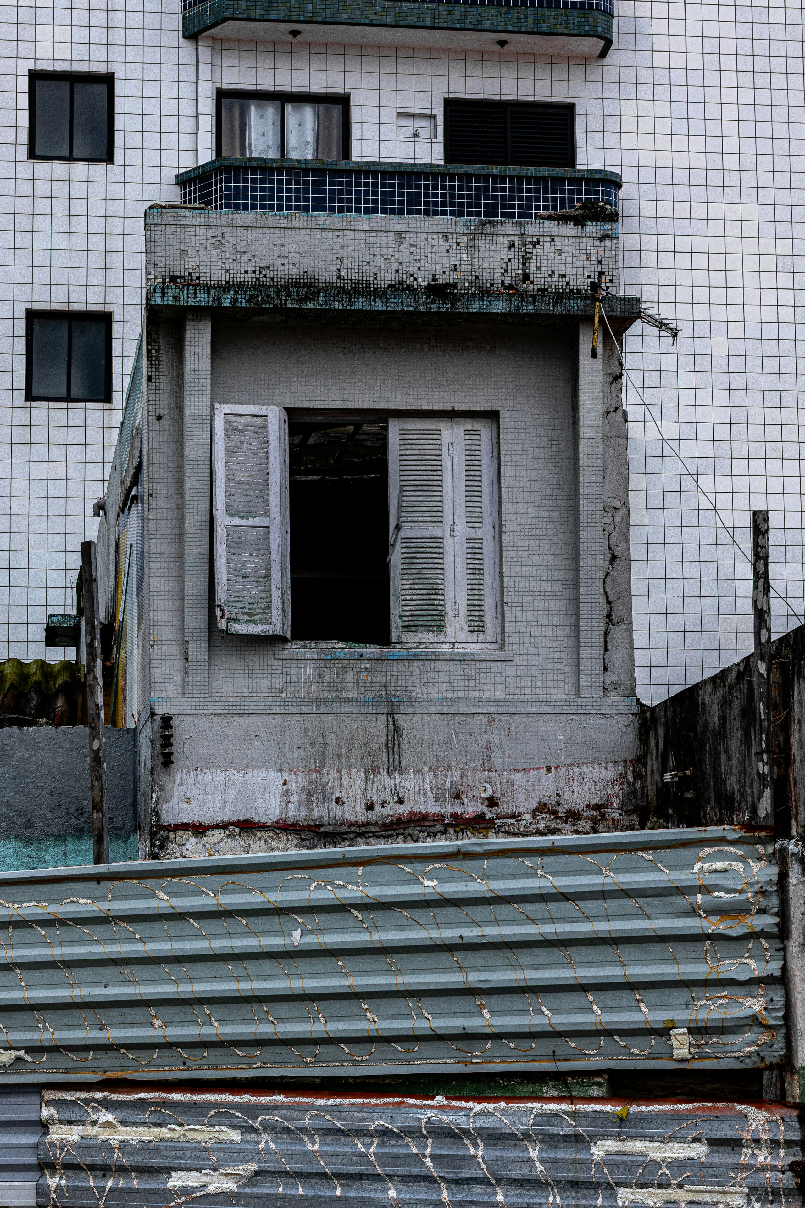 Weathered Balcony Dormer: A City Block’s Quiet Decay