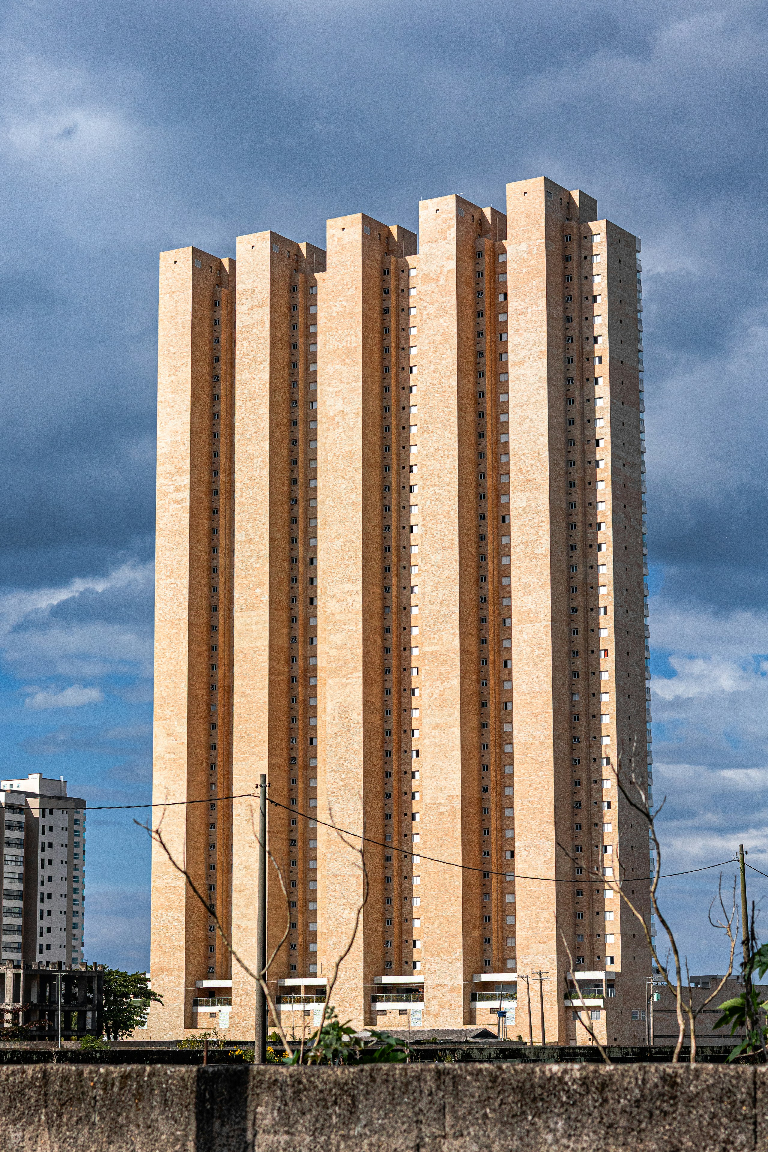 Vertical Concrete Skyline: A Climb of Brick Towers Against a Dramatic Sky