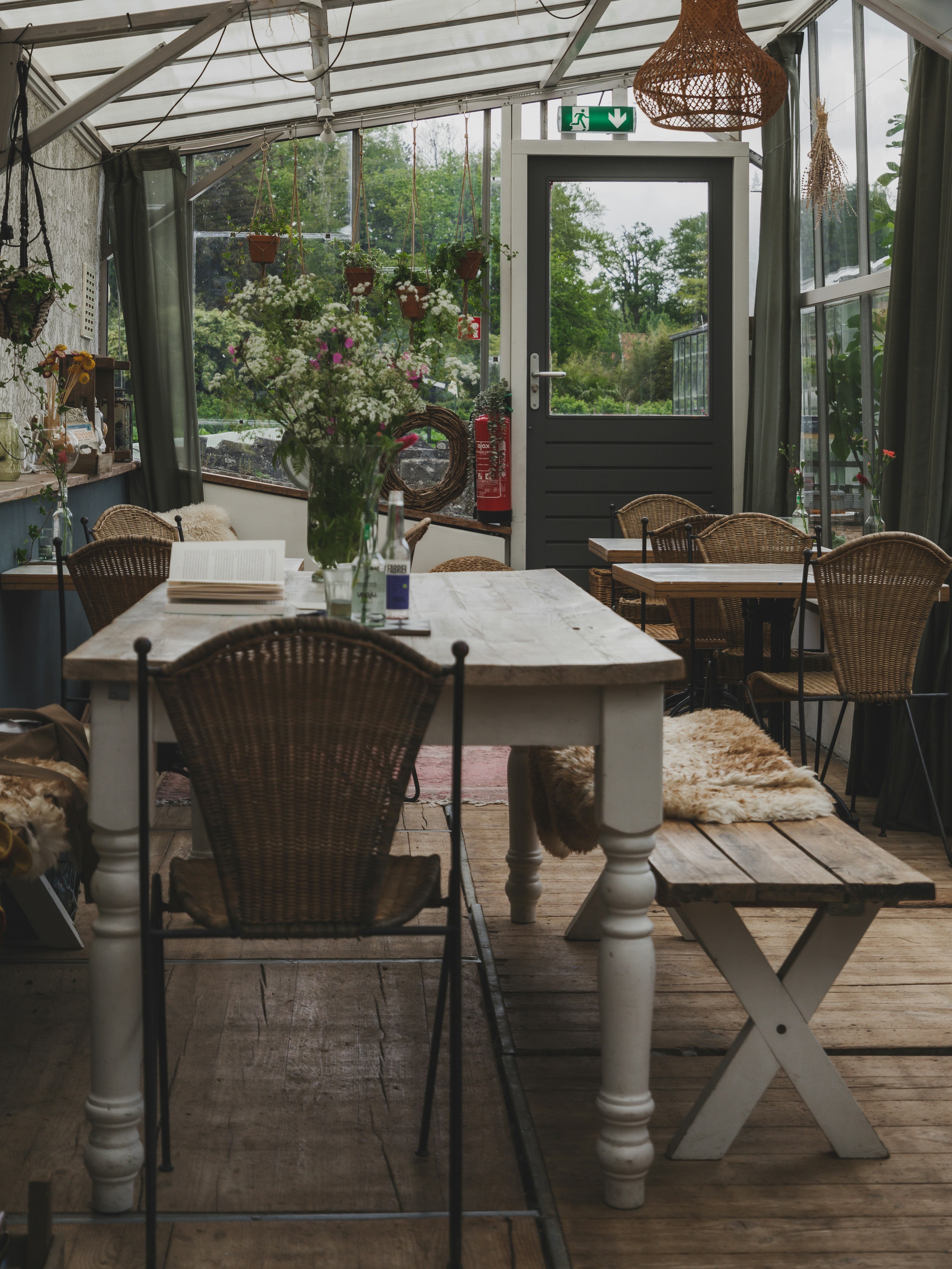 Sunlit Café in Glasshouse: A Quiet Table Beside the Door