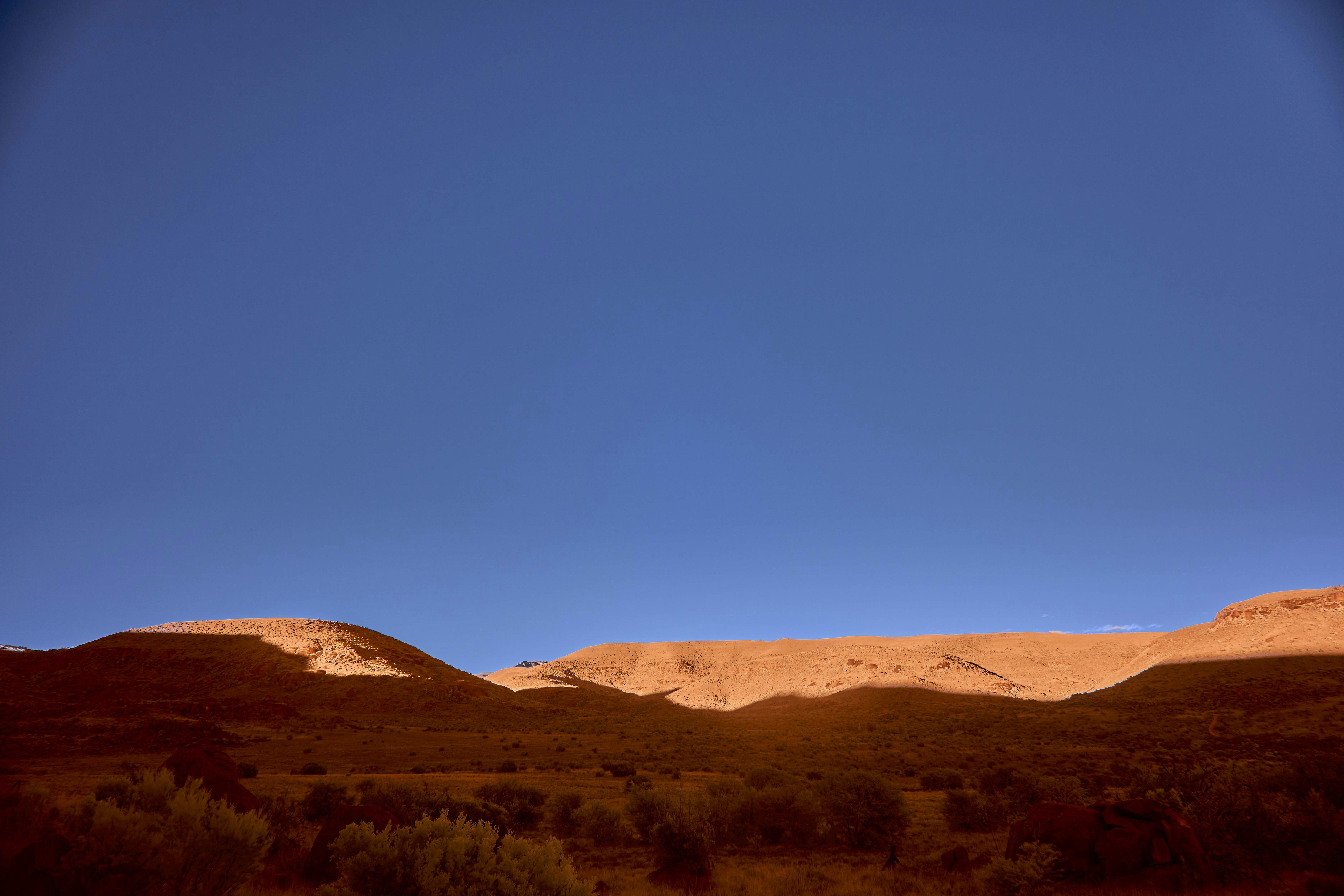 Desert Horizon Under a Clear Blue Arc