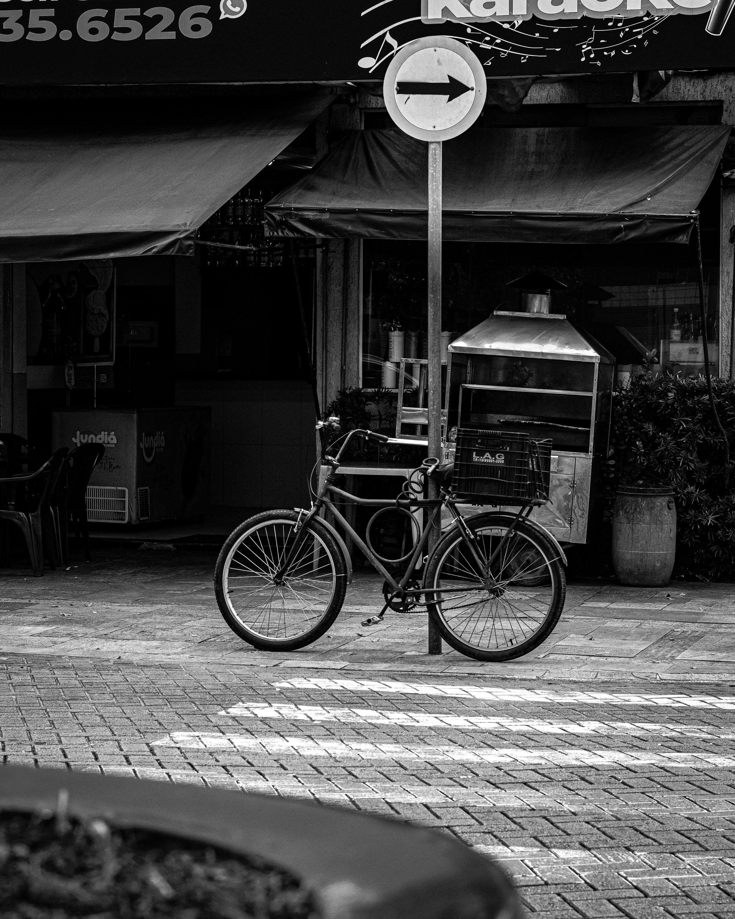 Bike and street clock: still life in monochrome