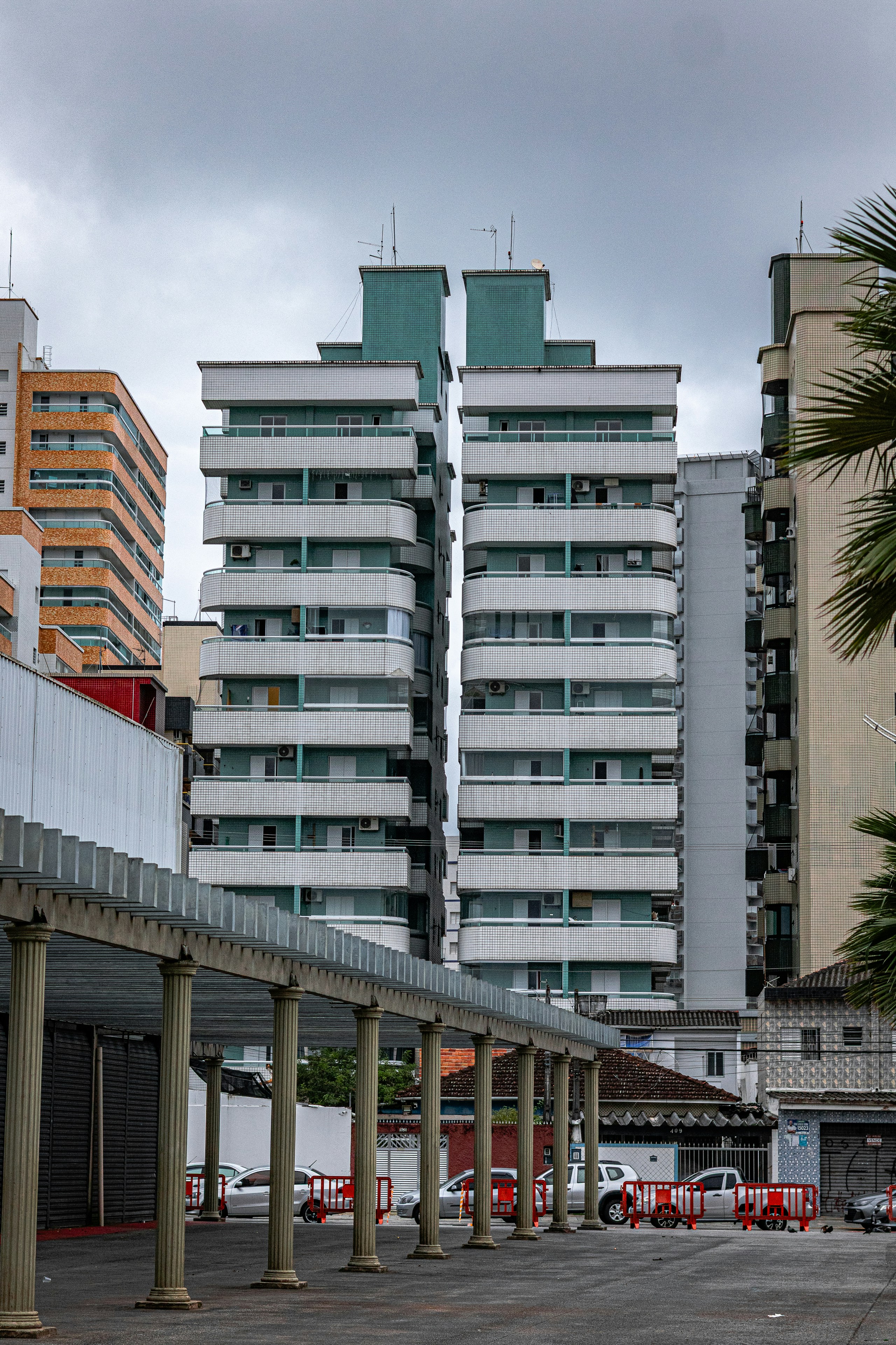 Twin turquoise towers framed by urban corridor