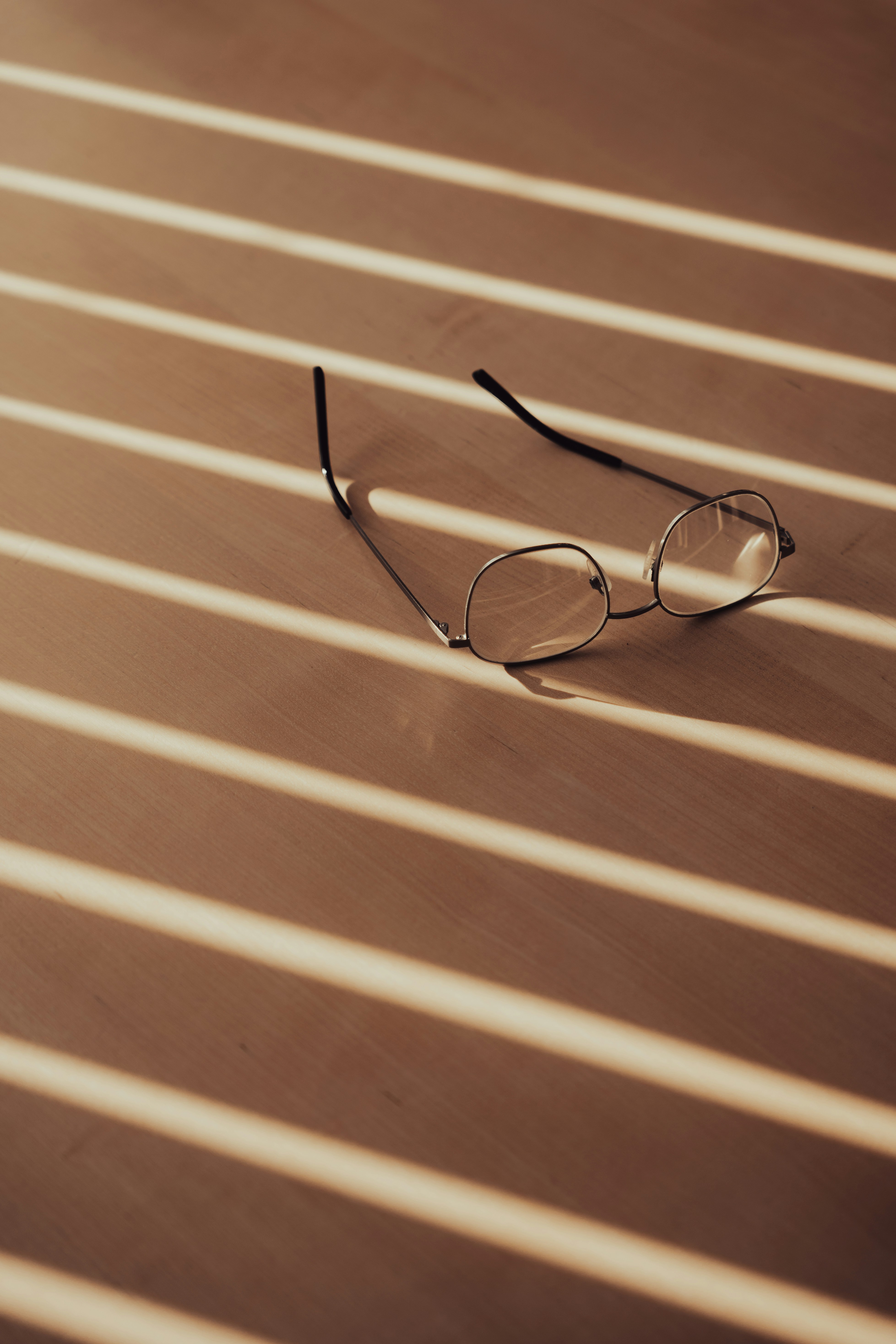 Glasses Cast in Stripes: A Quiet Study of Light and Shadow