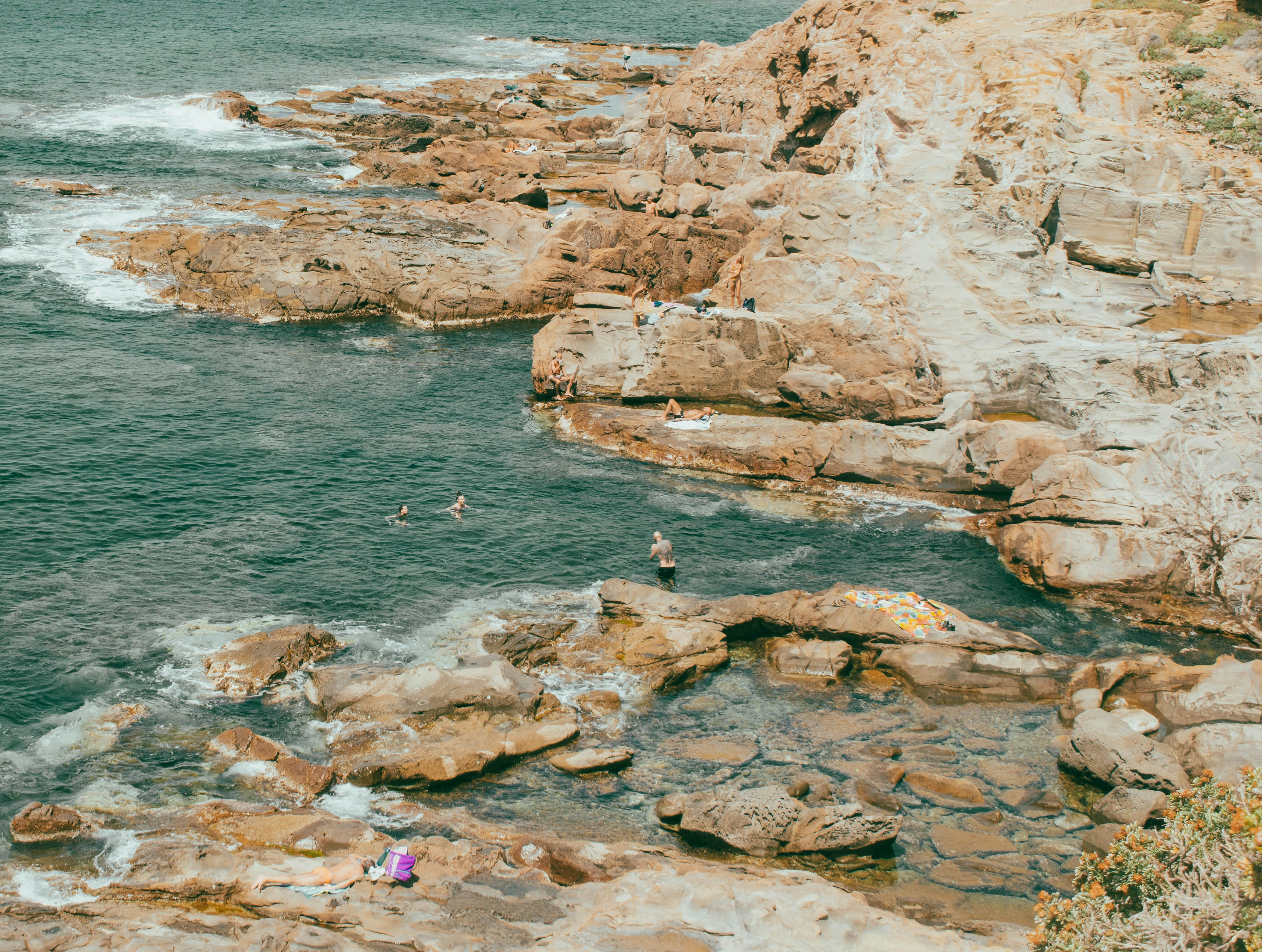 Coastal Rockscape: Light, Water, and Small Figures