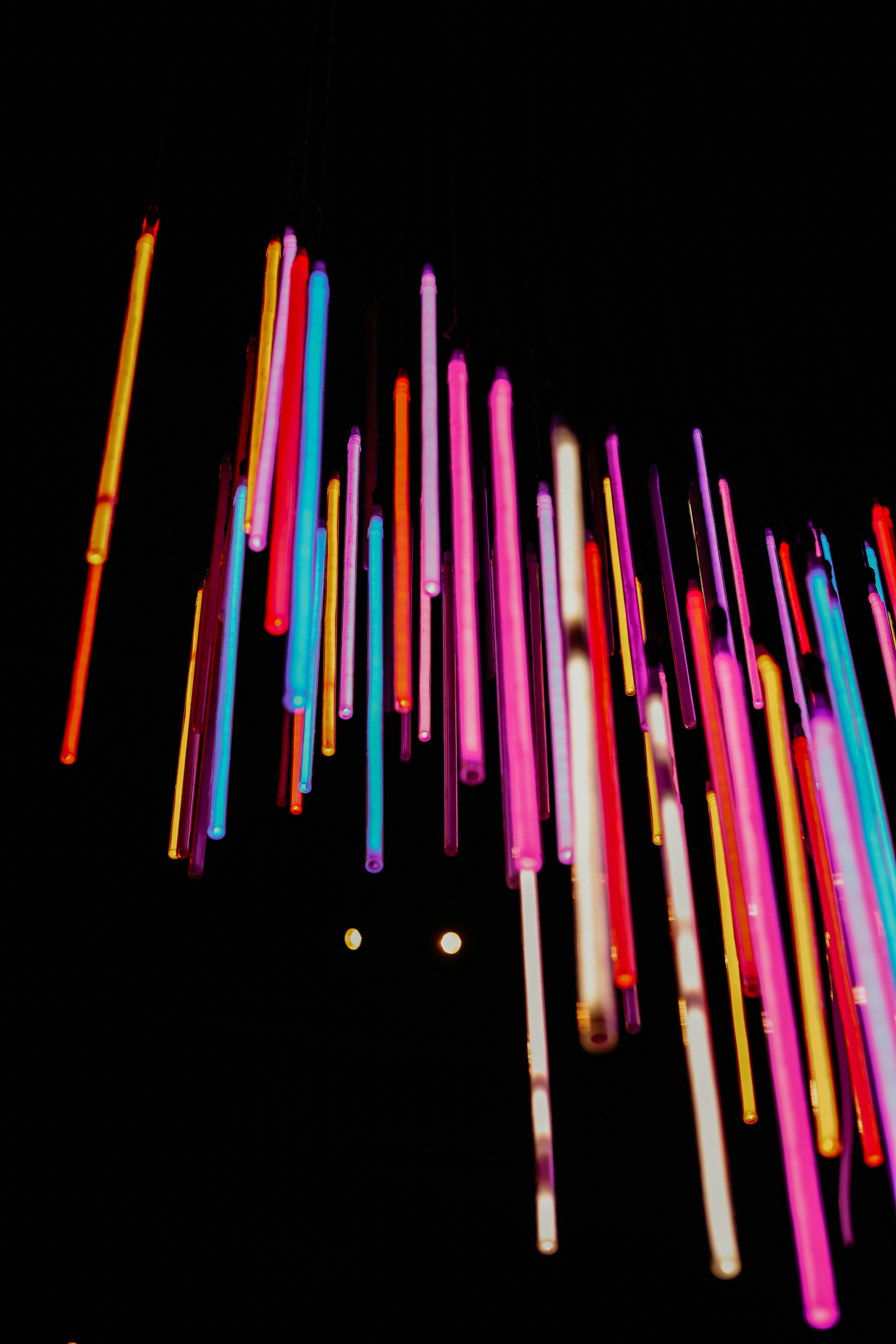 Neon Rain: A Row of Dancing Light Rods Against Night