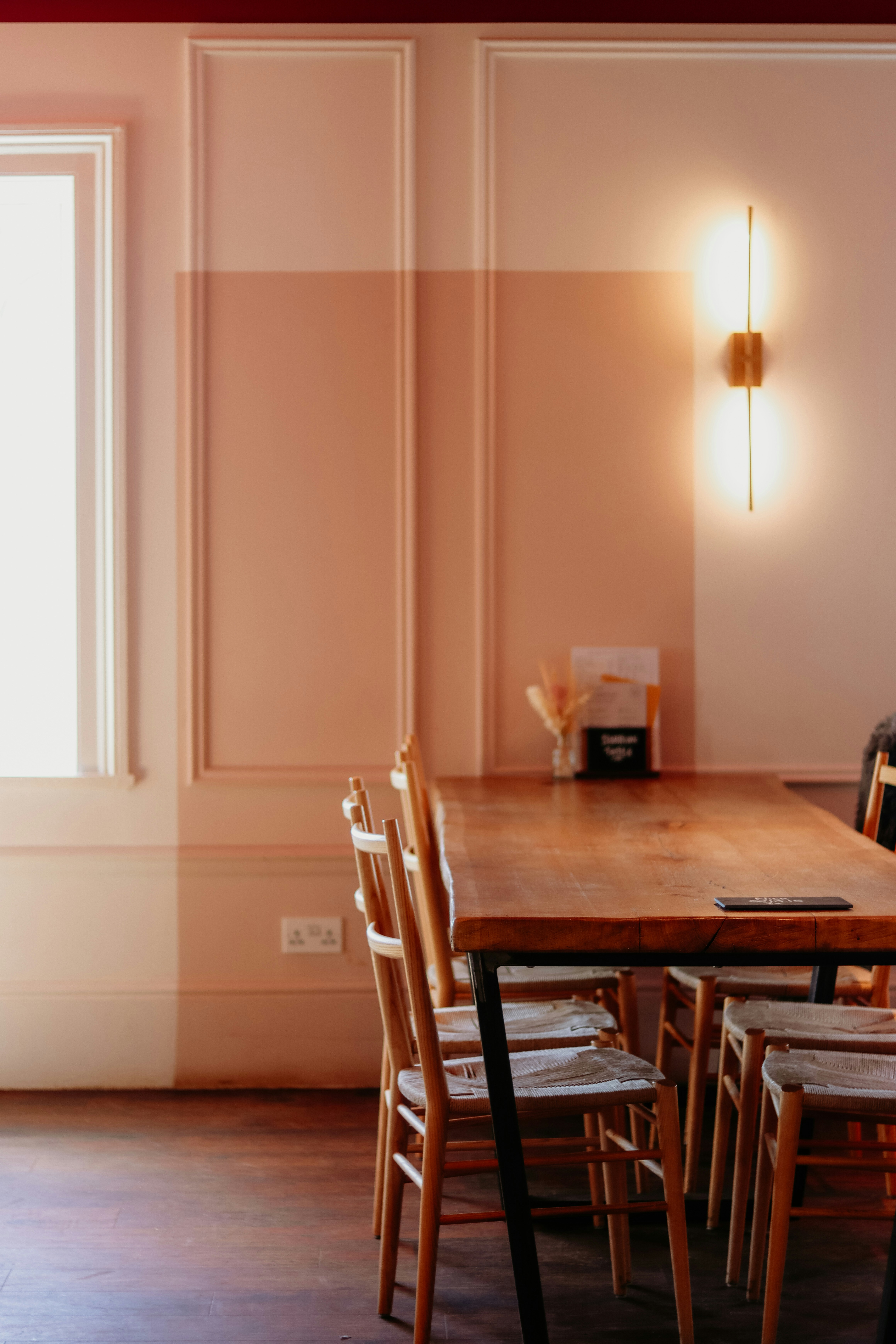 Warm Minimalism: Sunlit Dining Room with Soft Glare