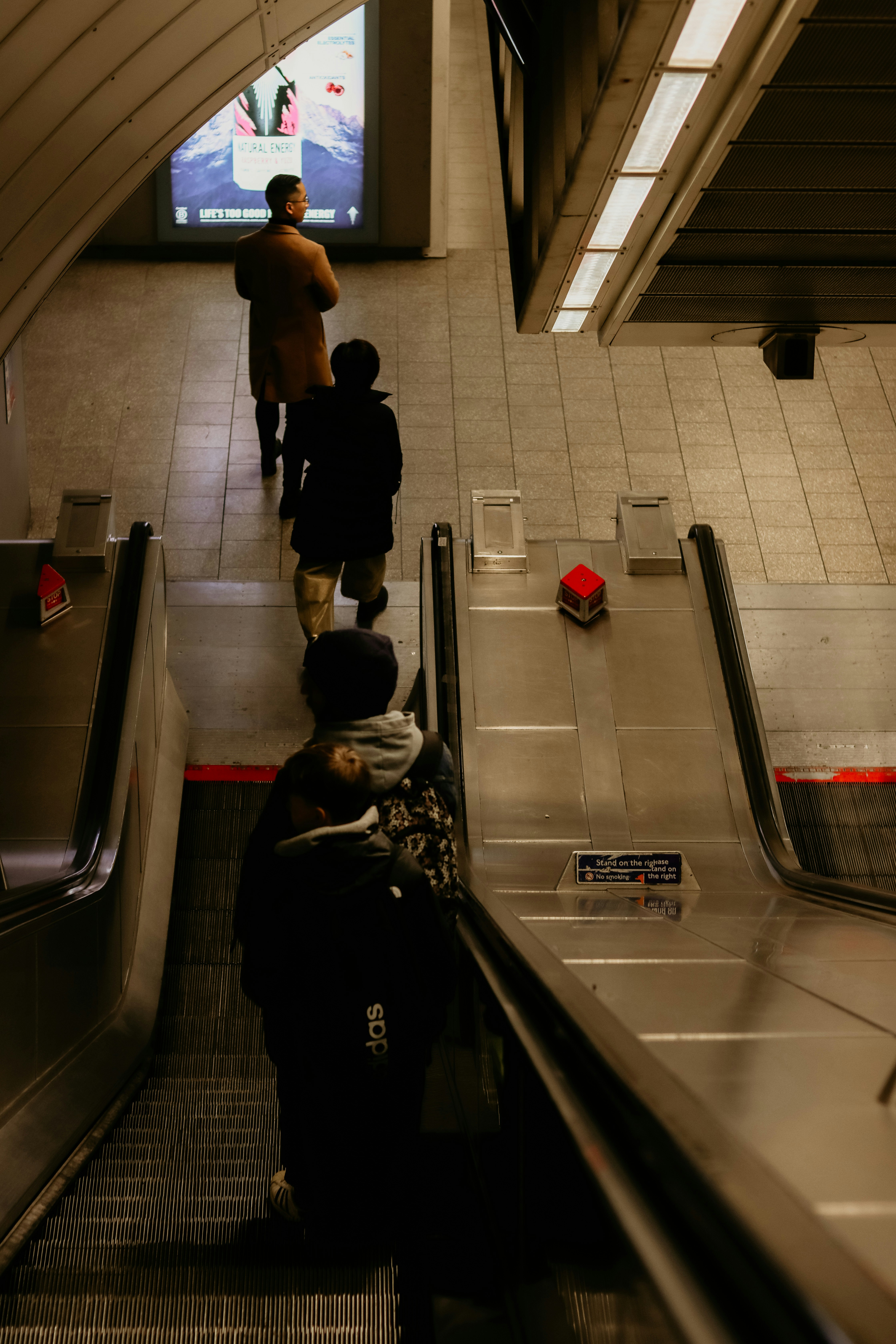 Matinee Descent: Travelers on the Quiet Subway Escalator