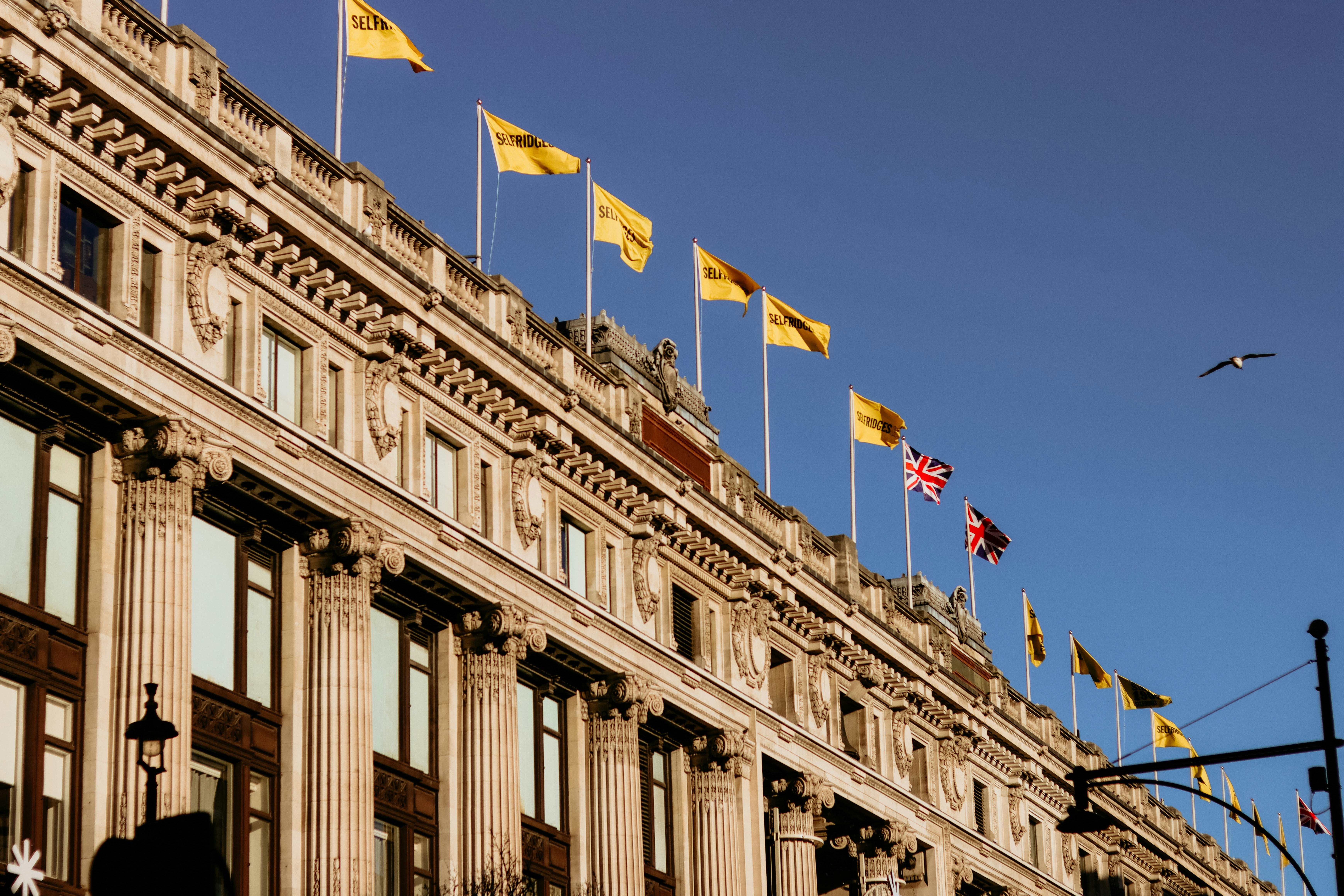 Flag-lined facade under azure sky