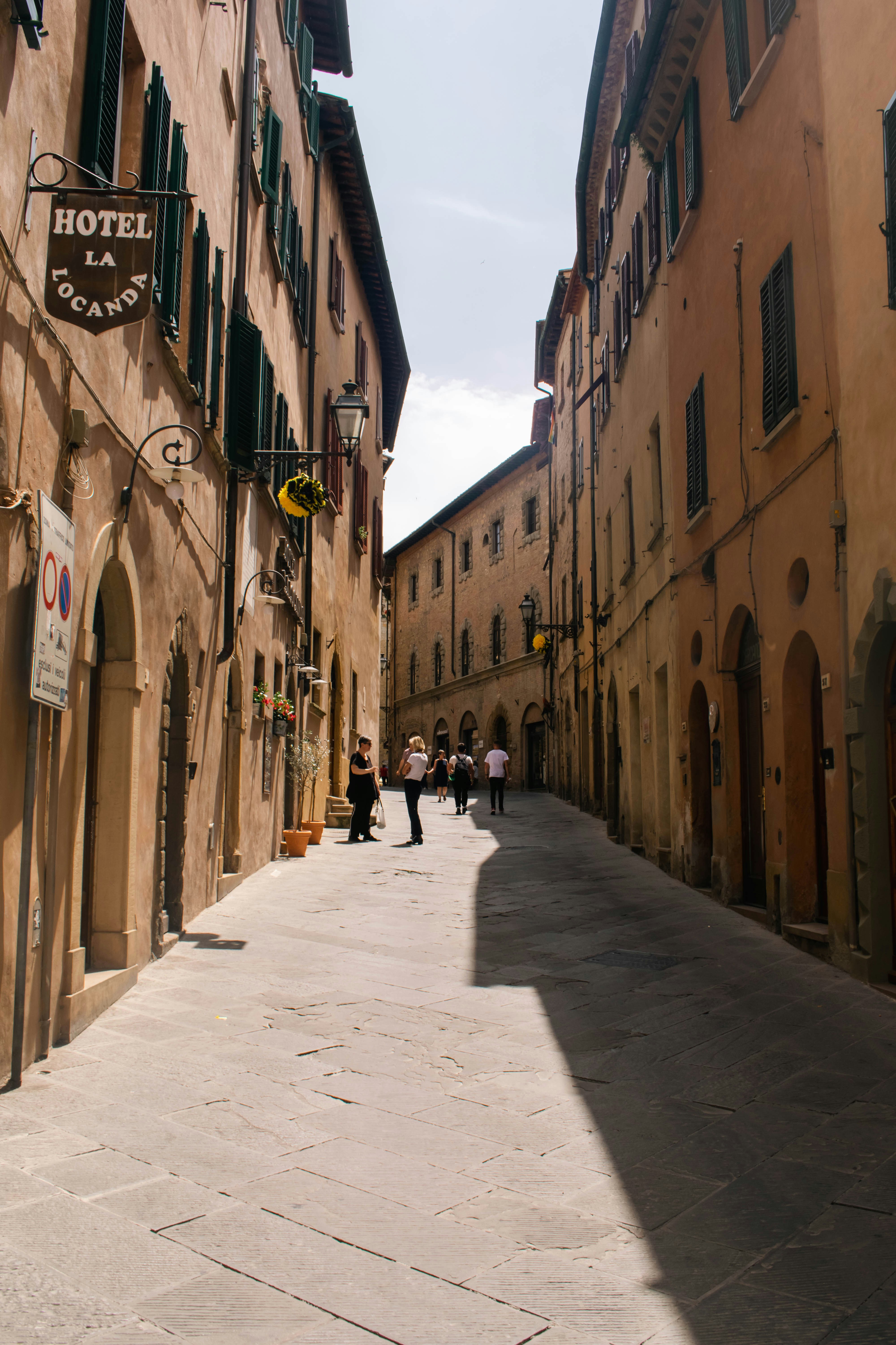 Sunlit Tuscan Lane: A Quiet Lift Between Historic Facades