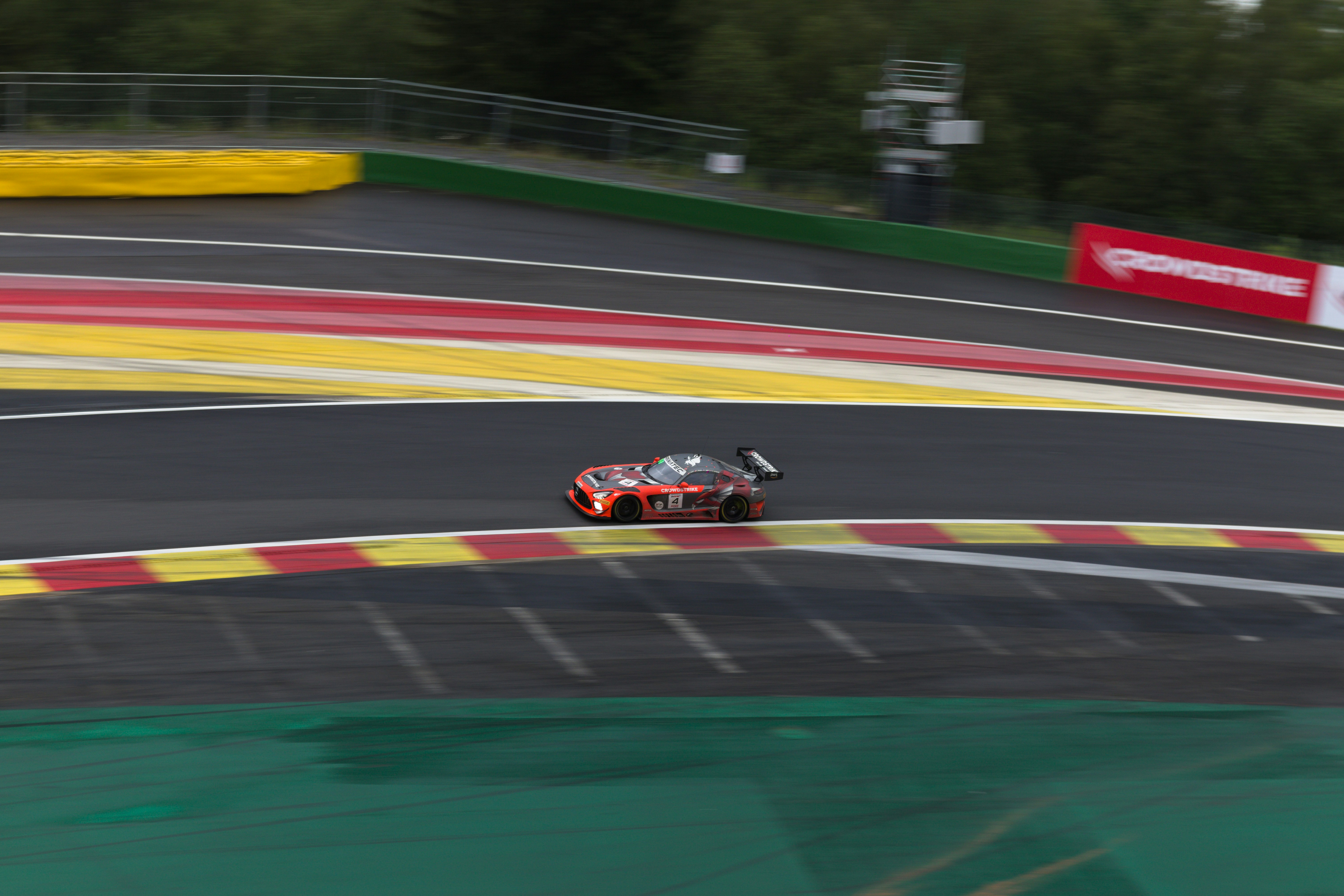 Red Racer in the Midfield Drift on a Curved Circuit