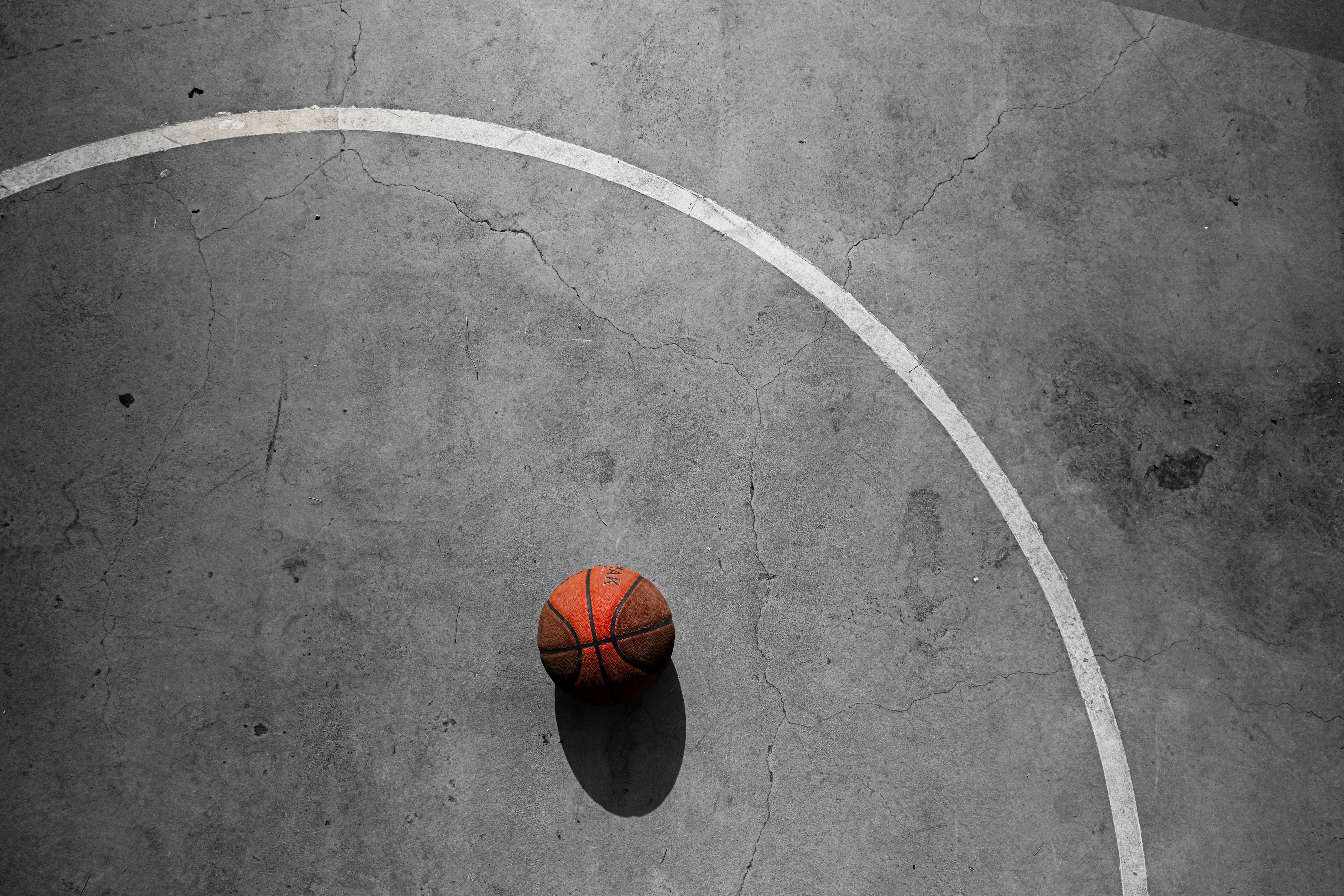 Centered Dribble: lone basketball on a curved court line