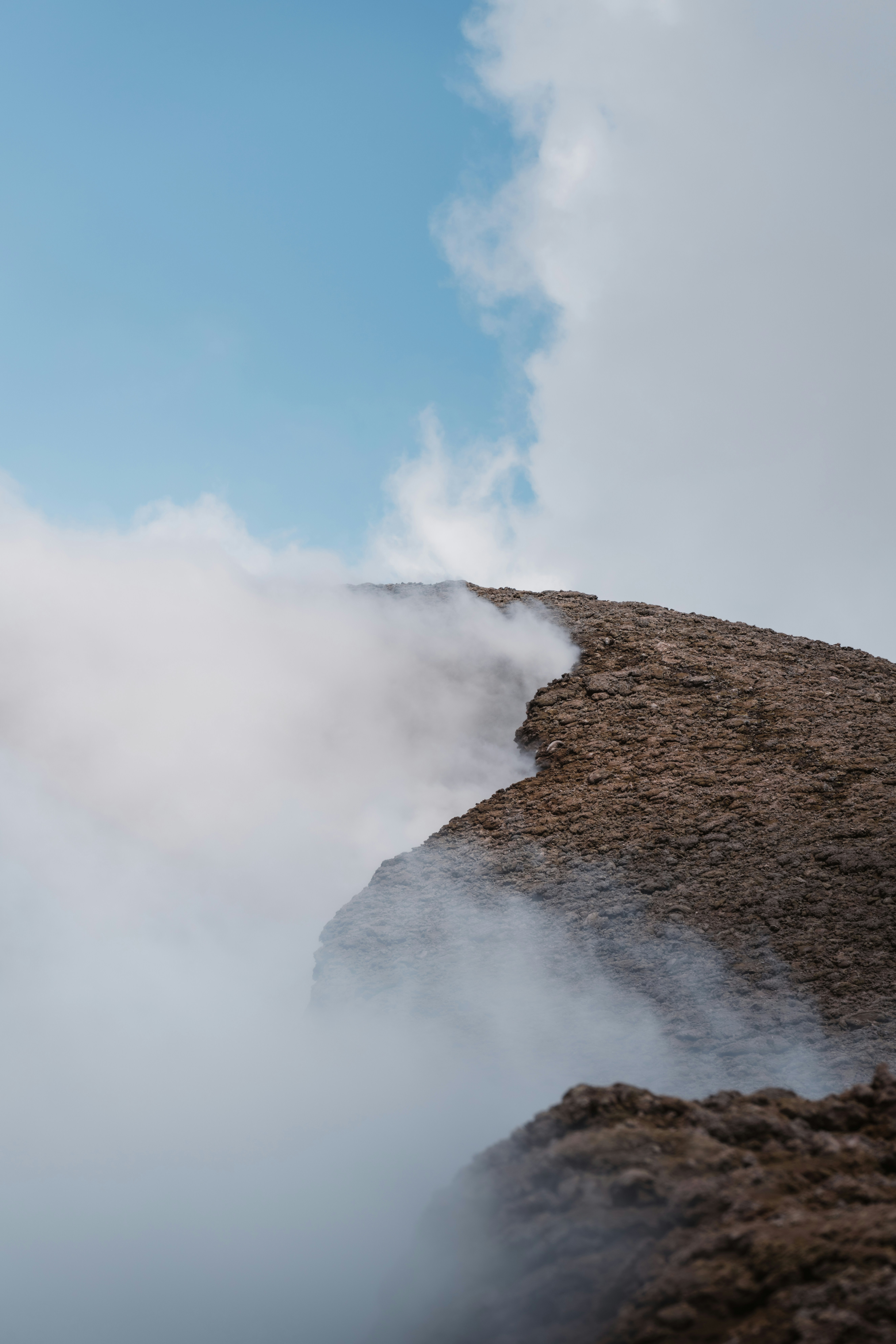 Misty ridge: volcanic rock emerging from clouds