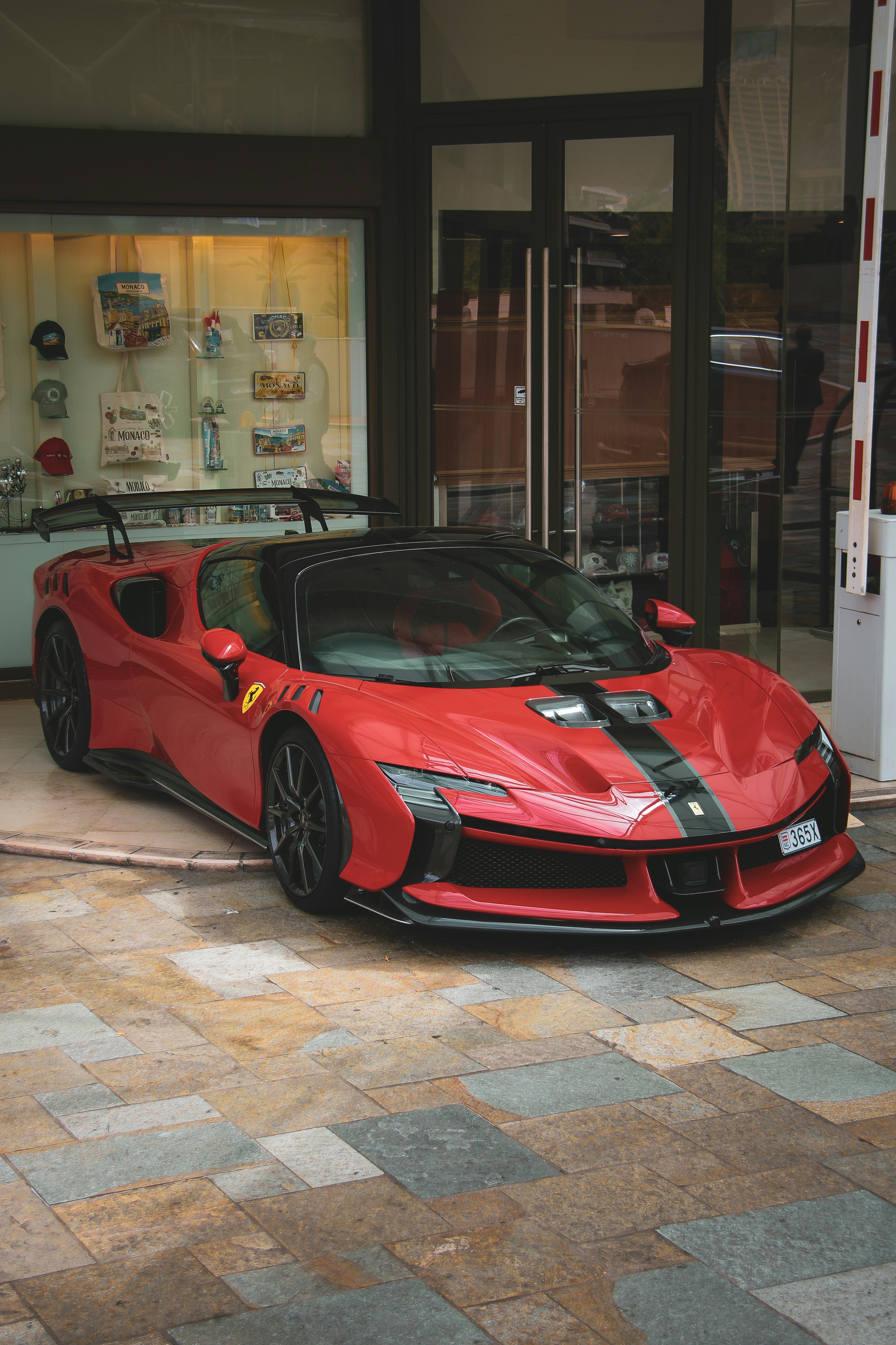 Red Ferrari Slotted into a Modern Storefront Display