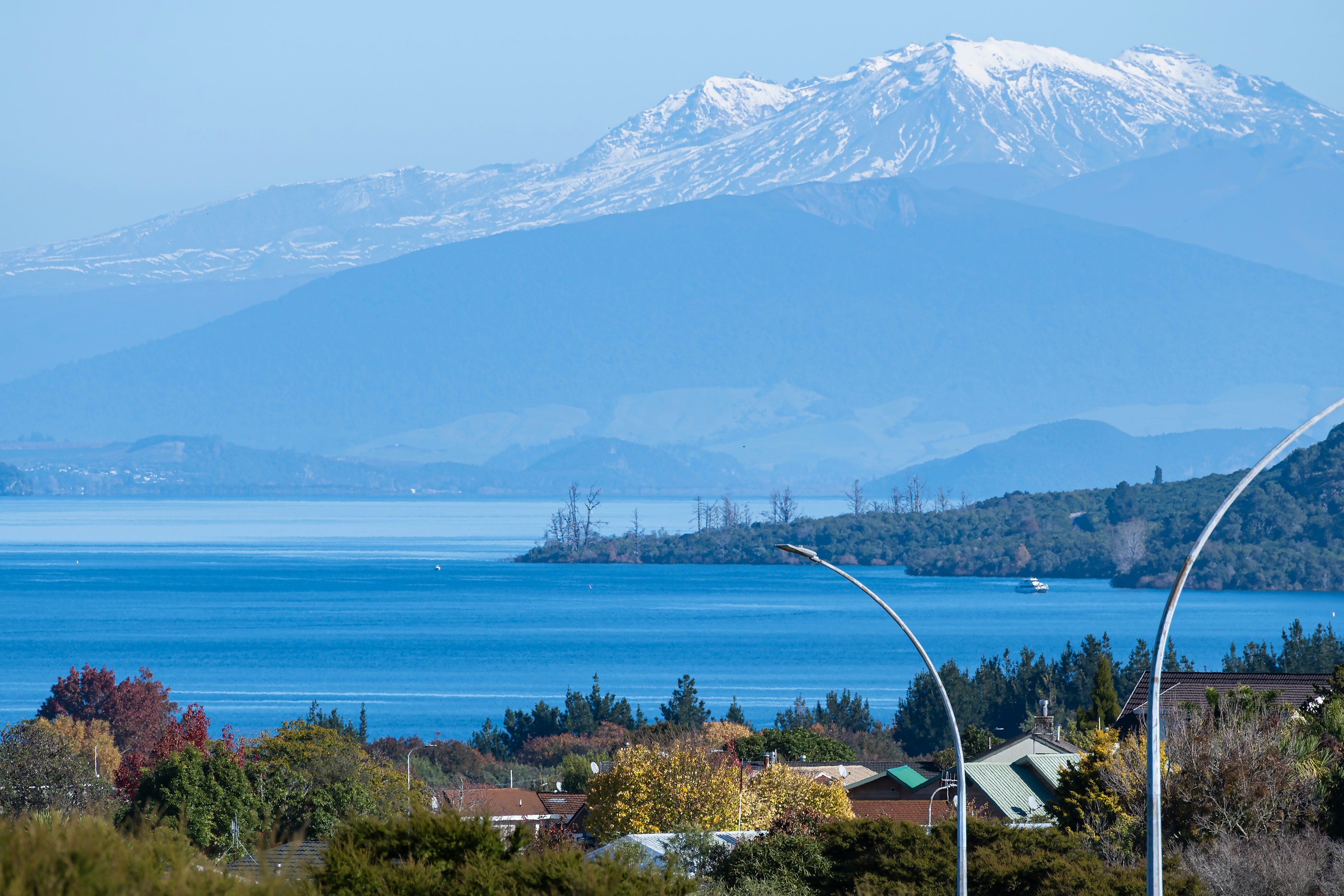 Quiet Coastal Village beneath Snow-Capped Giants
