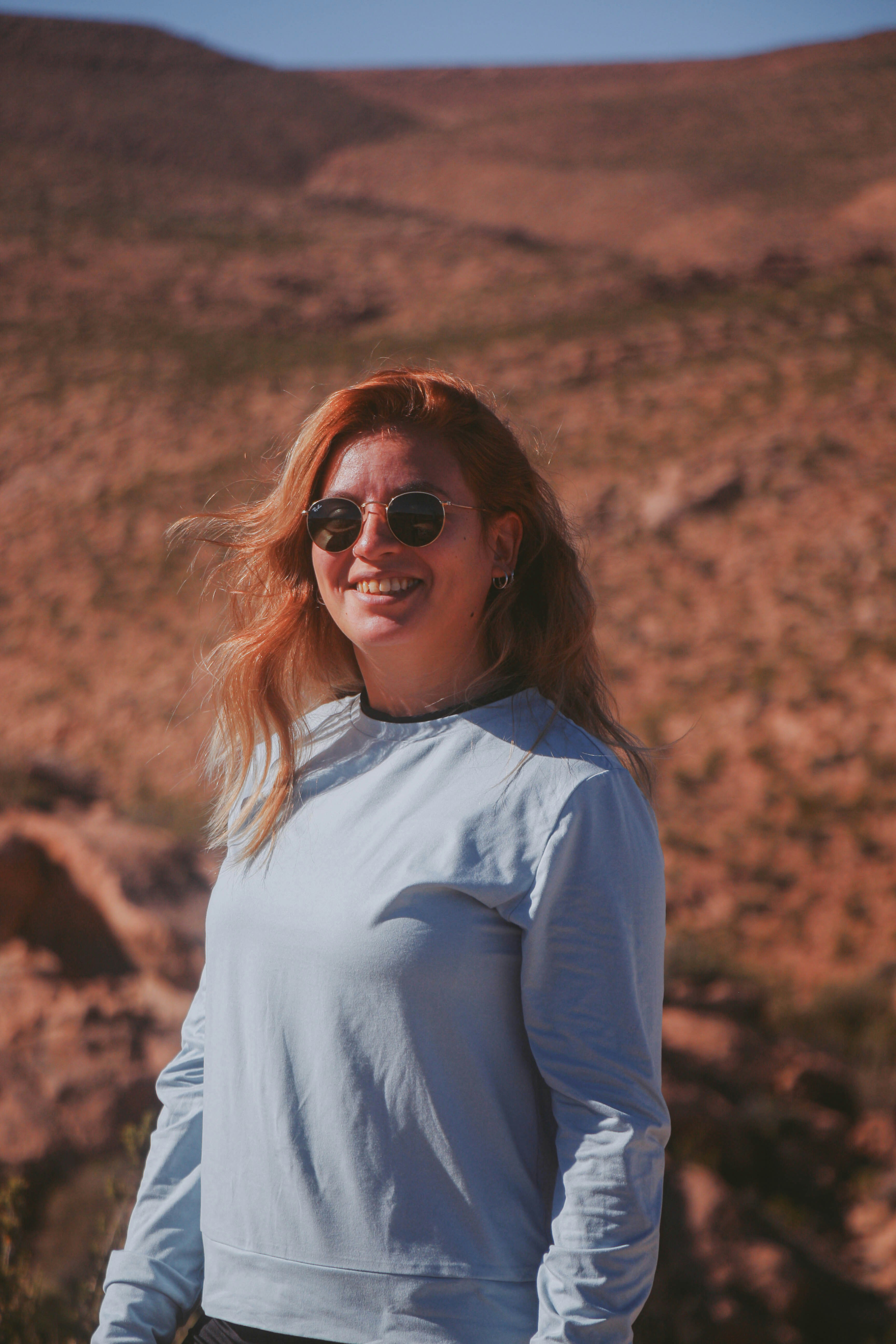 Red-haired portrait in sunlit desert ridge