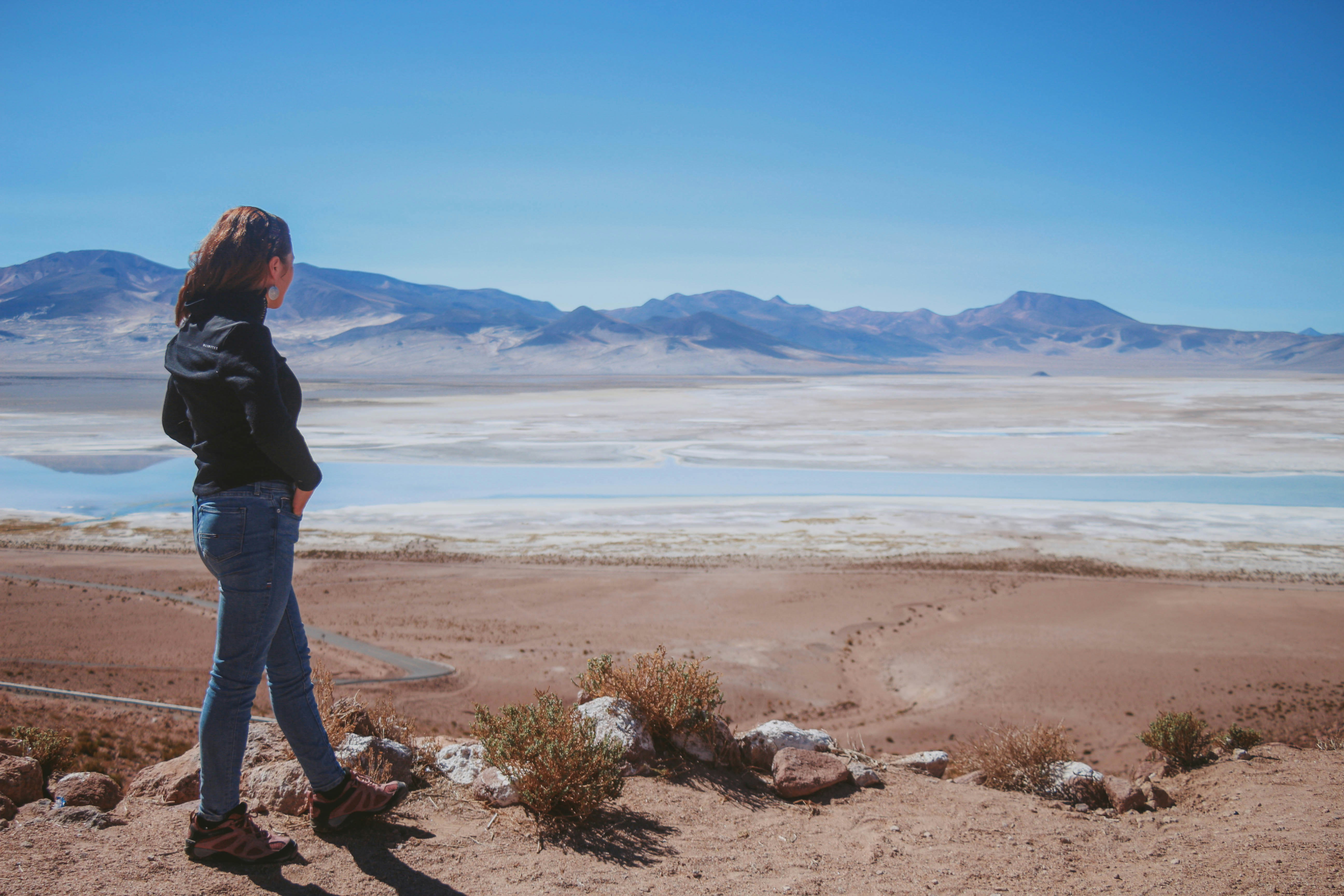 Desert Edge Stance: A Lone Figure Against Wide Horizons