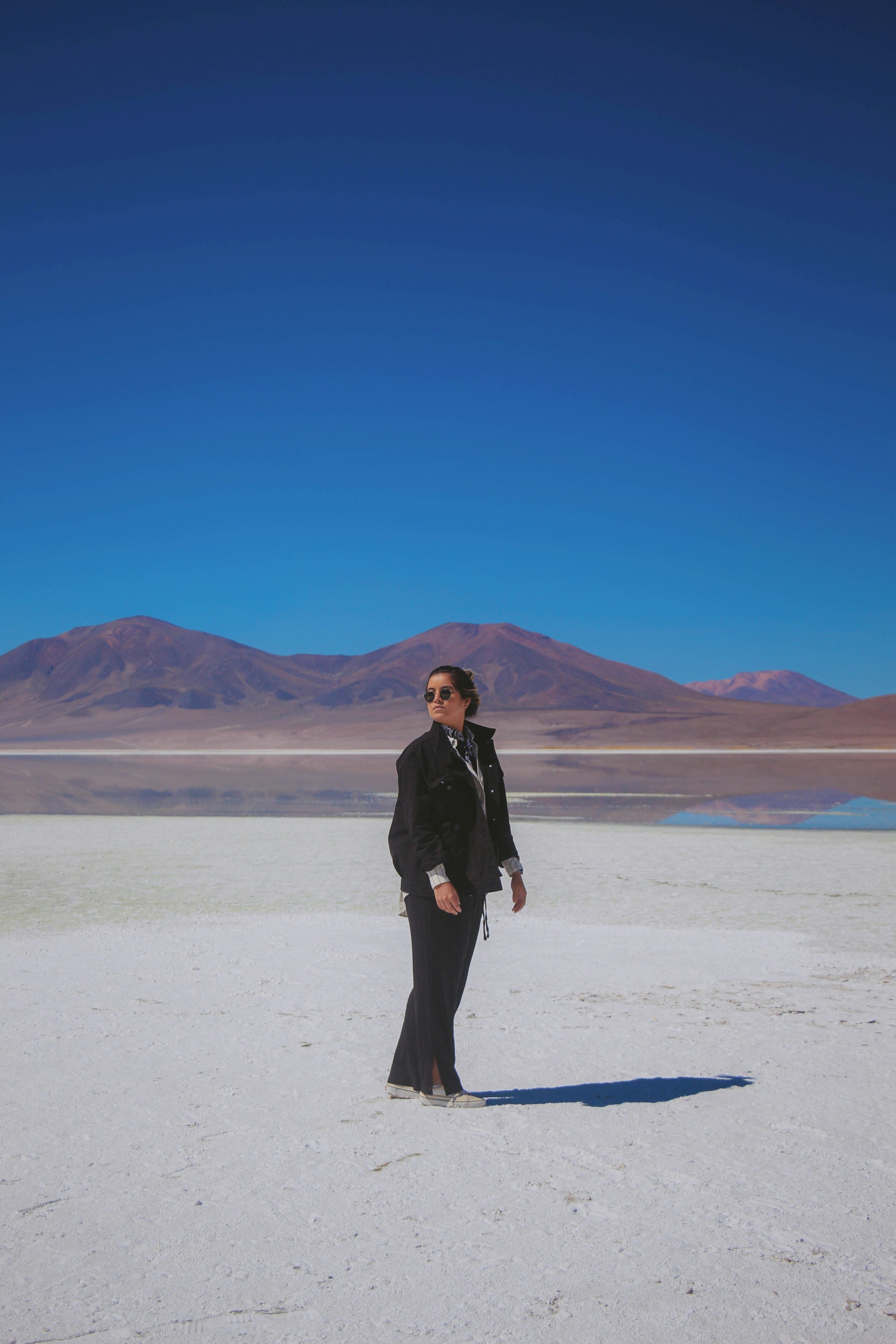 Desert Mirror: A Solo Traveler Beneath a Cerulean Sky