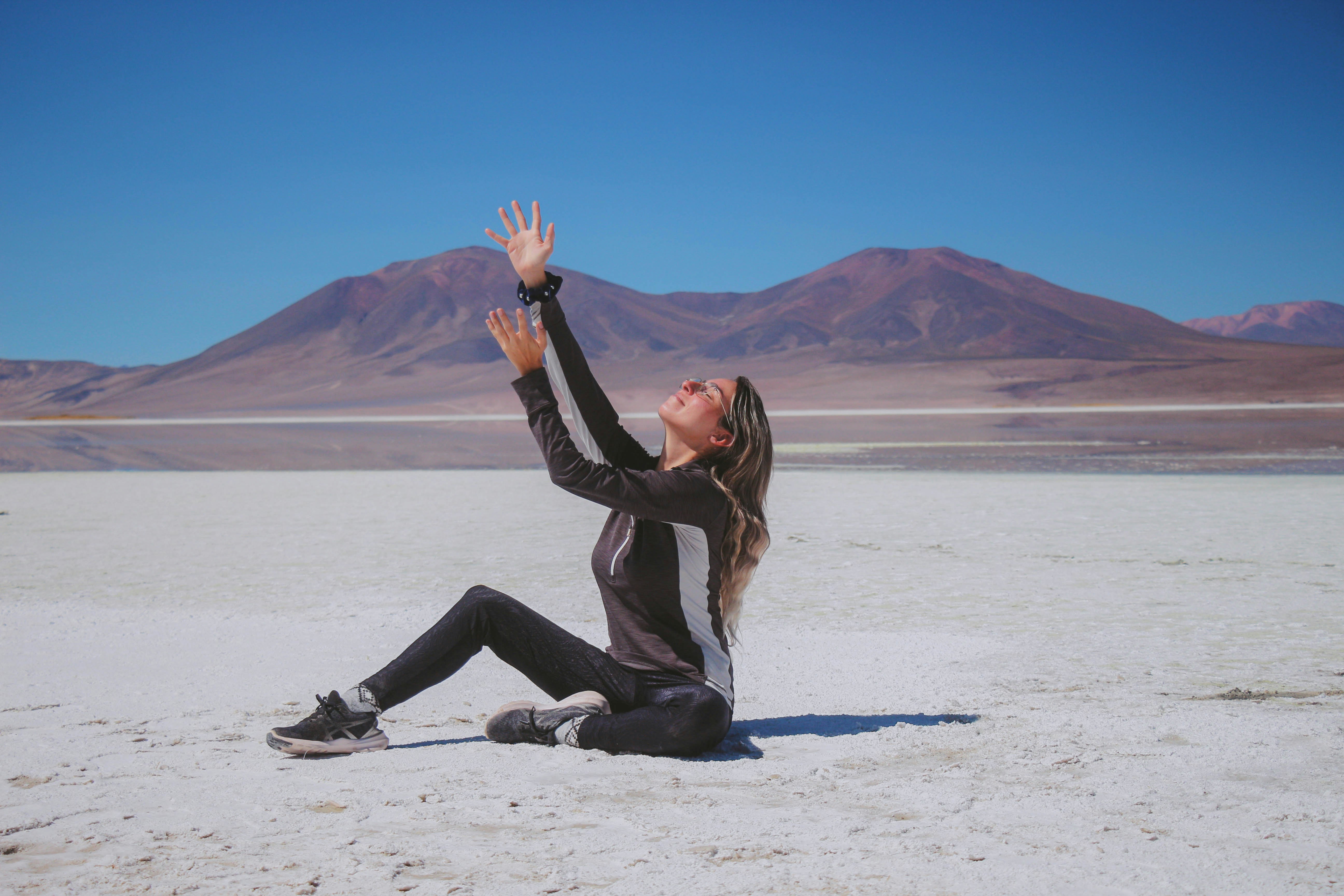 Desert Pose: A Solo Silhouette Reaches for the Sky on Salt Flats
