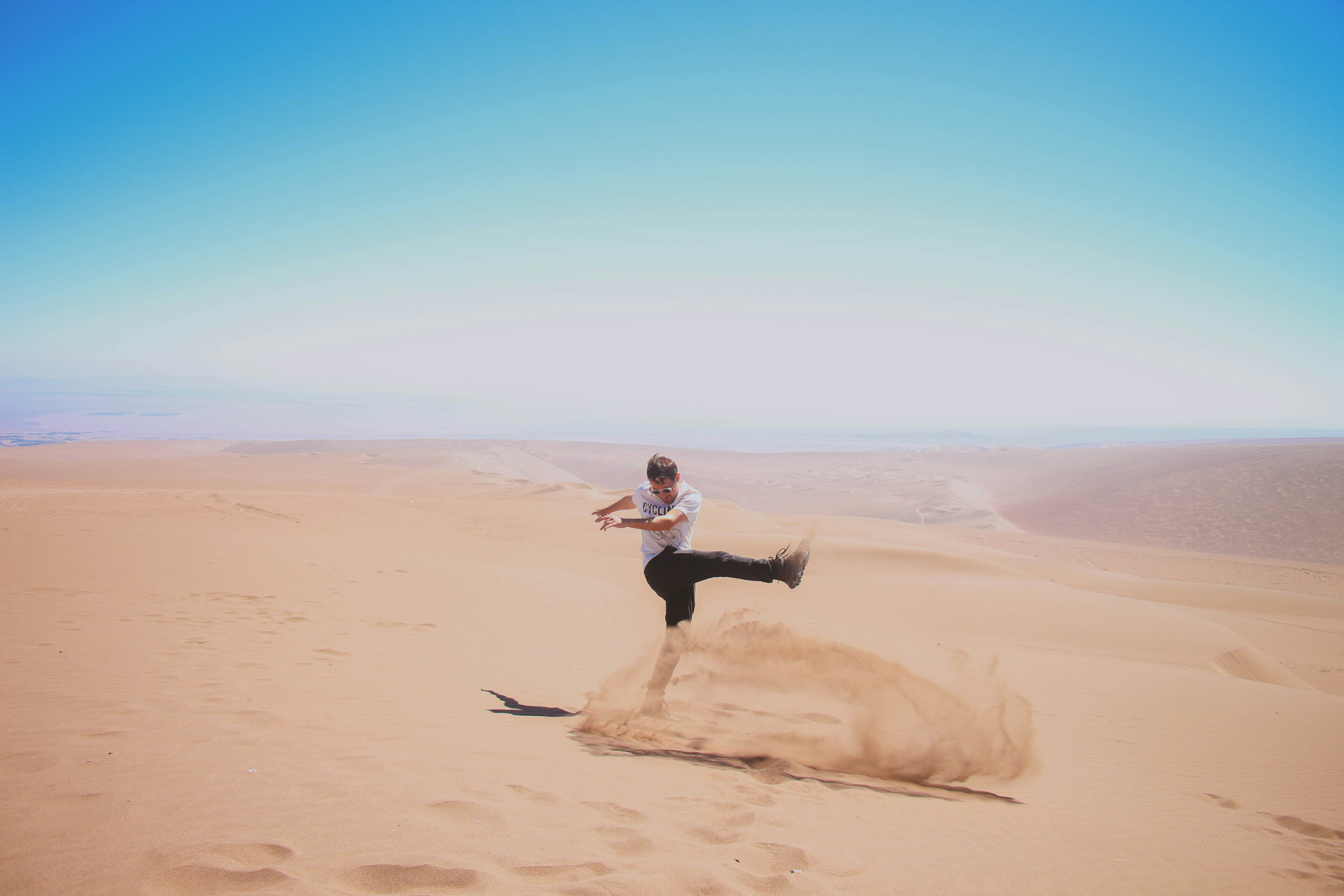 Desert Jump: A Dune Leap Against a Gradient Sky
