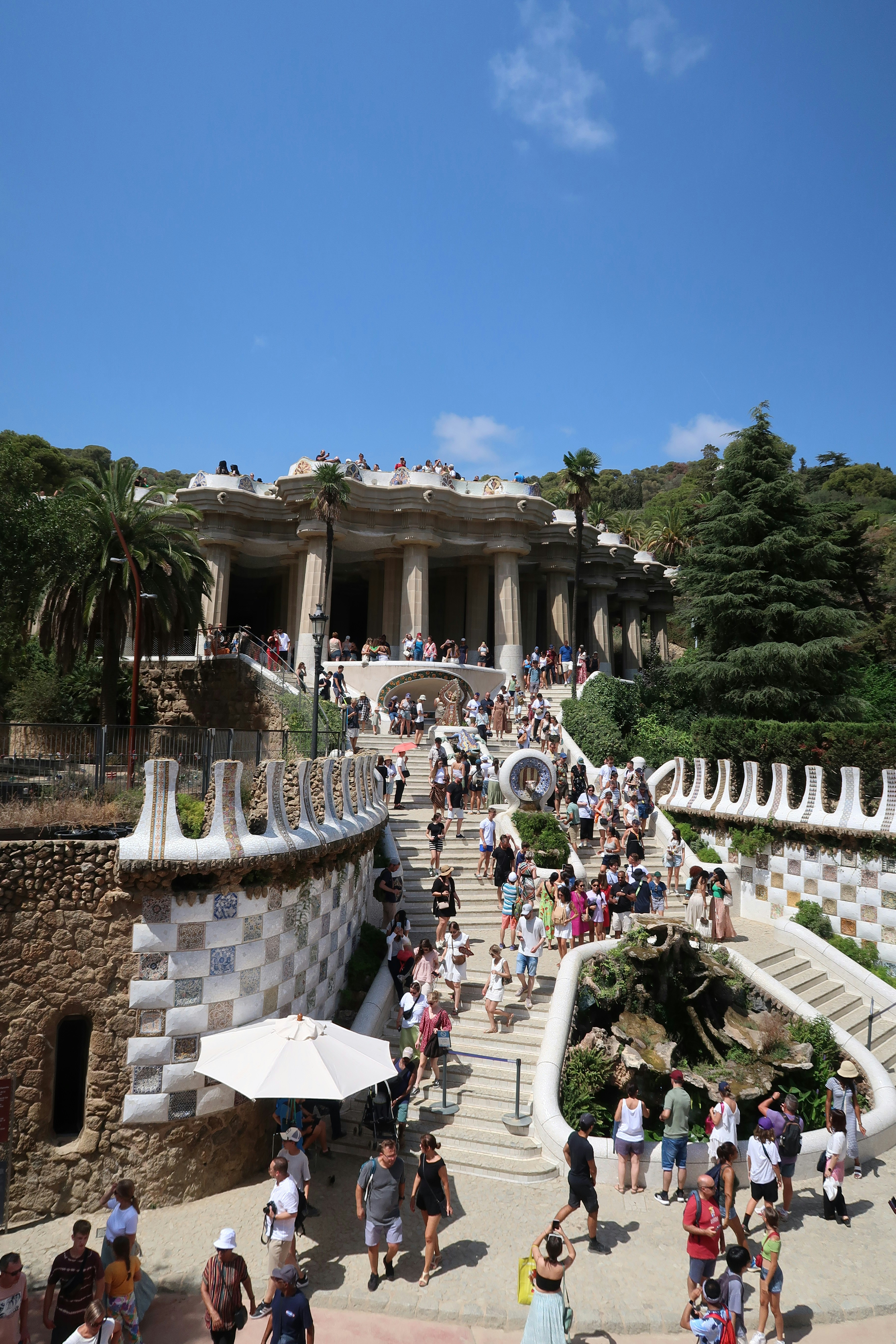 Nexus of Steps: Visitors Ascend a Terraced Oasis to a Sunlit Ornamented Terrace