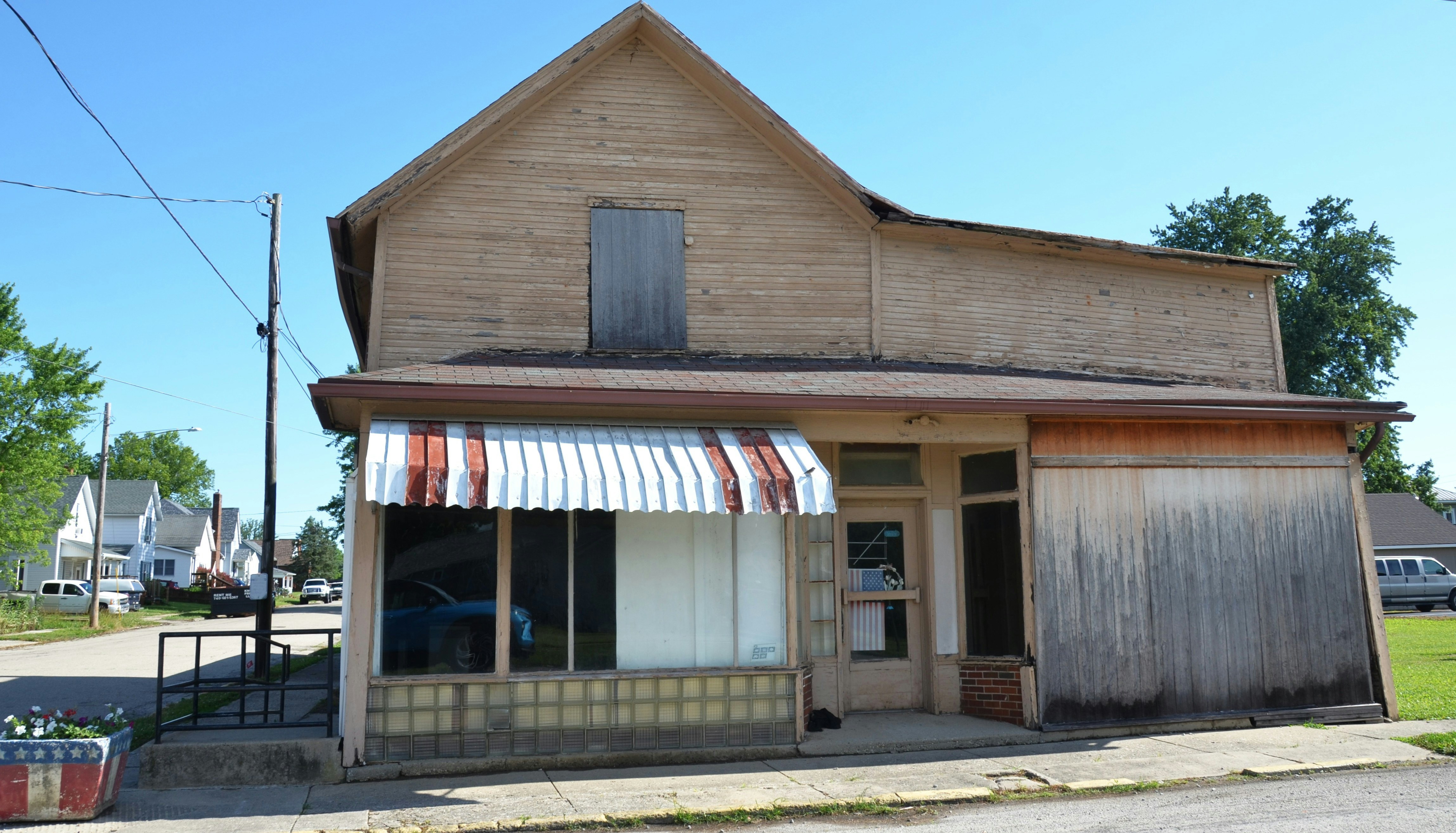 Abandoned storefront under a bright noon sky