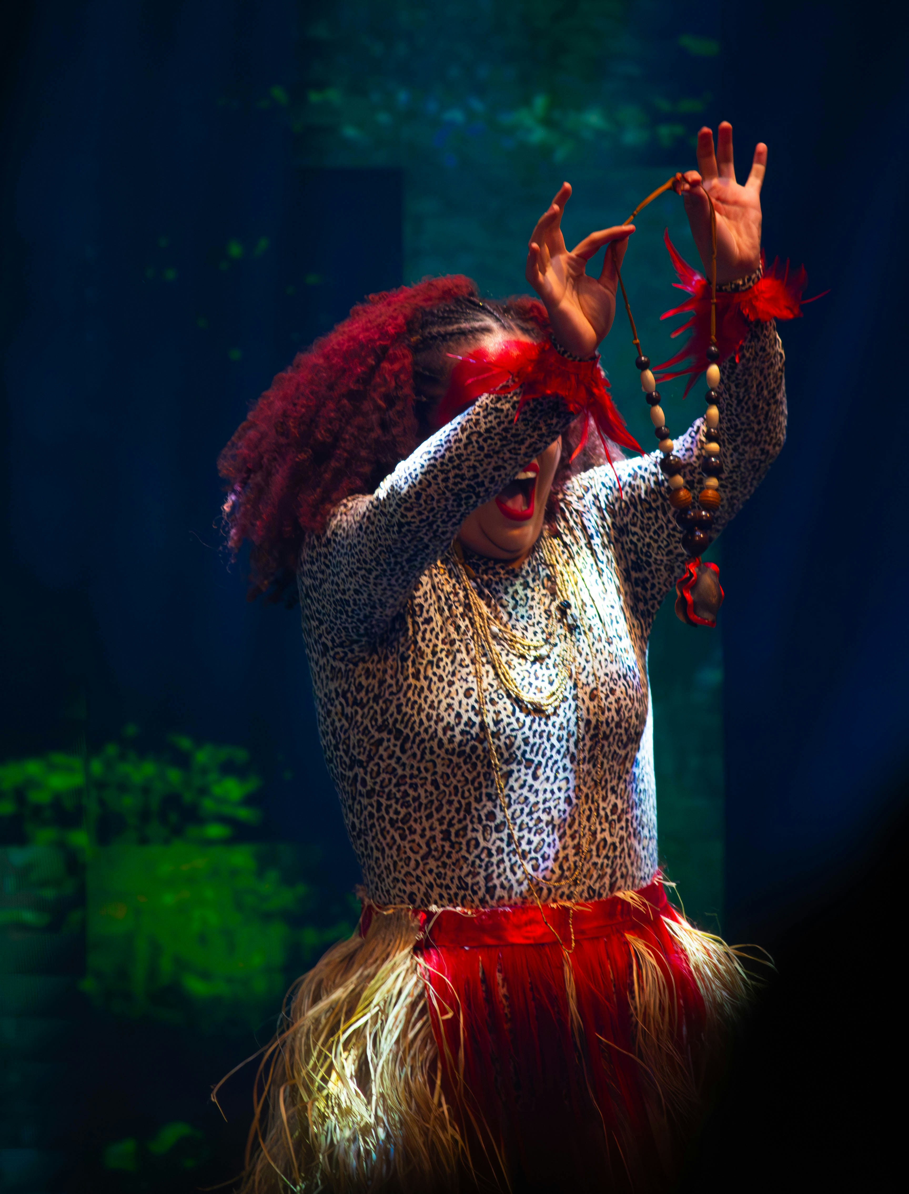 Energetic Tribal Dance with Leopard Print Top and Red Accents