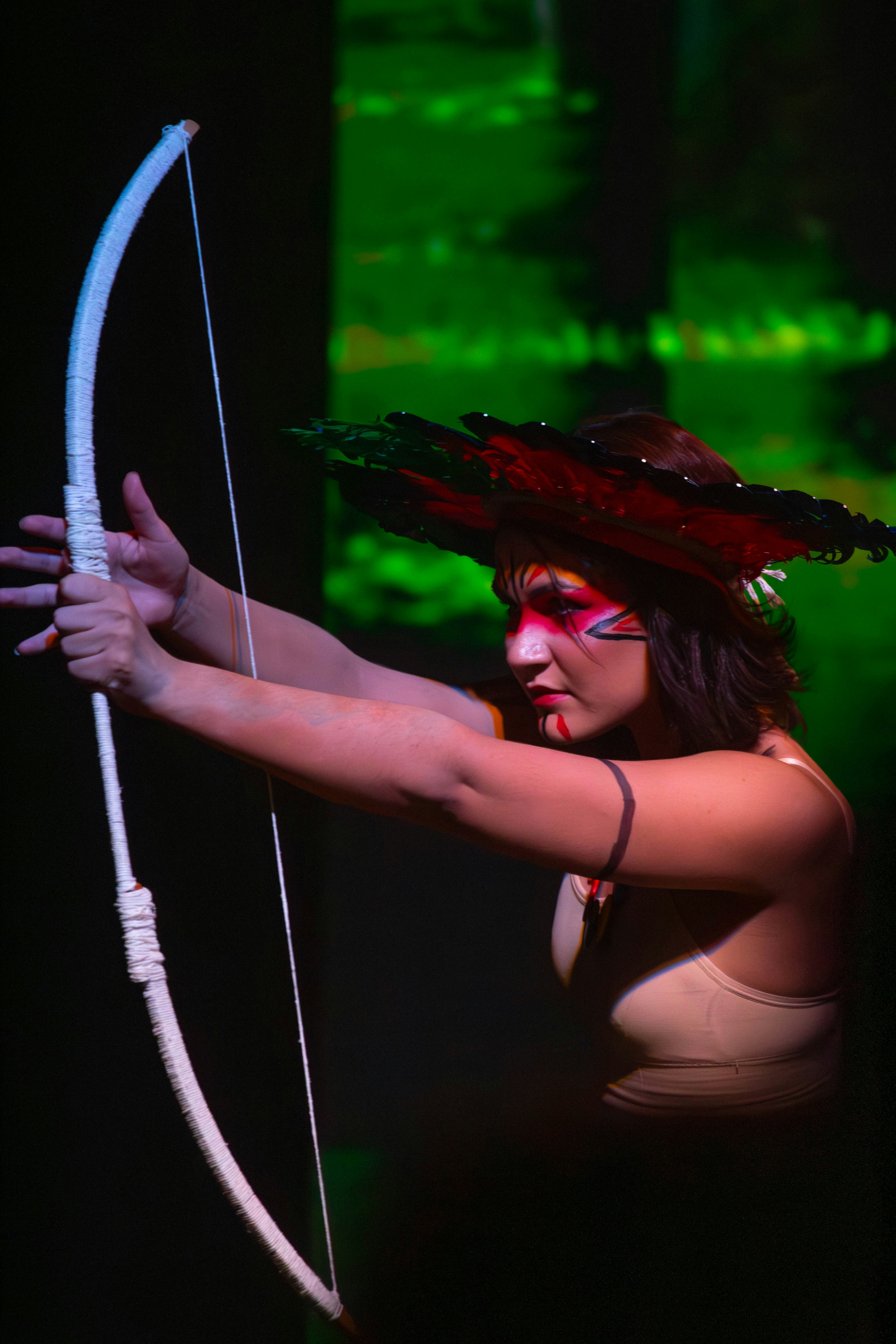 Arrow of Focus: Archeress silhouette in stage green glow