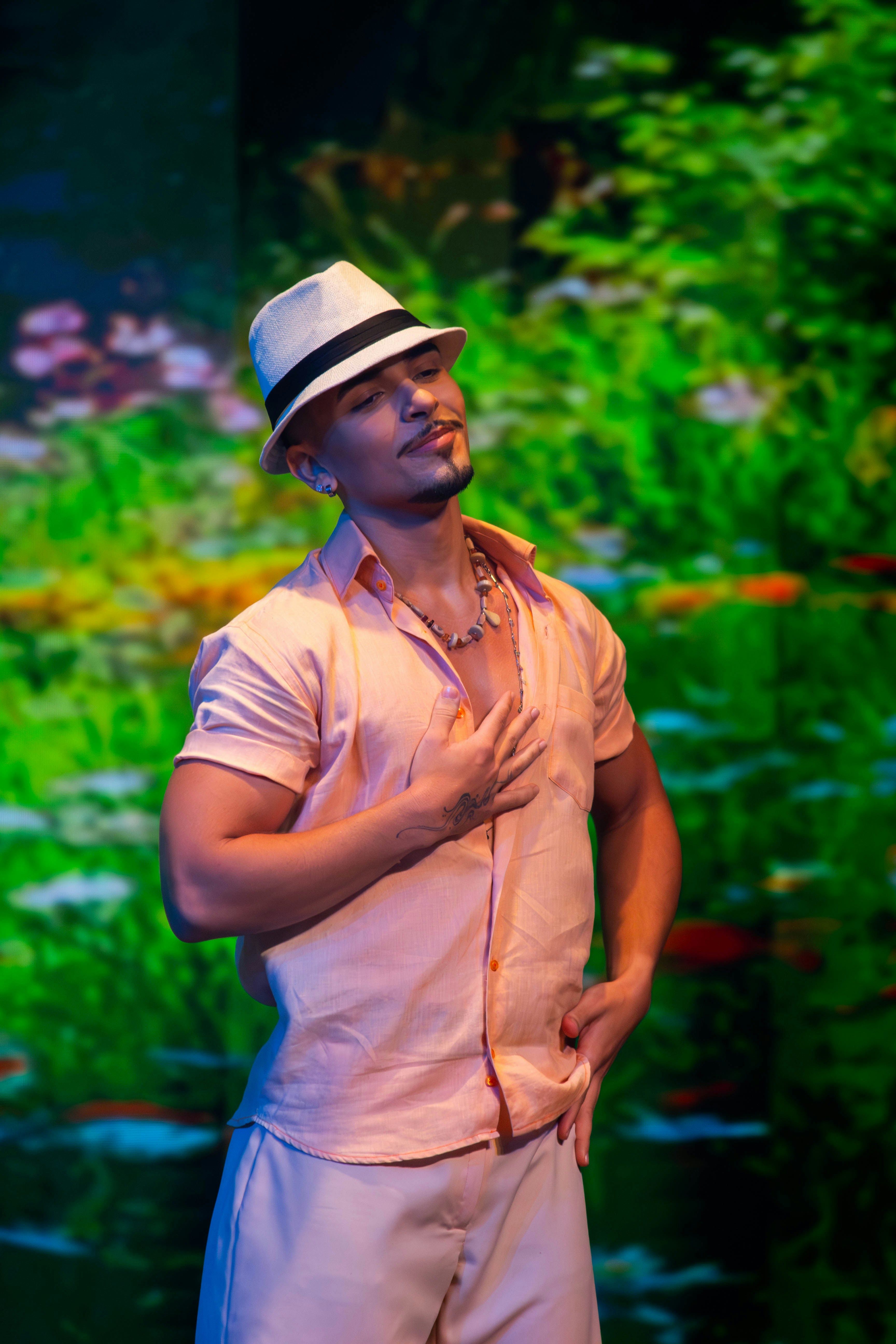 Sunlit Pose: A Relaxed Performer in Coral Attire
