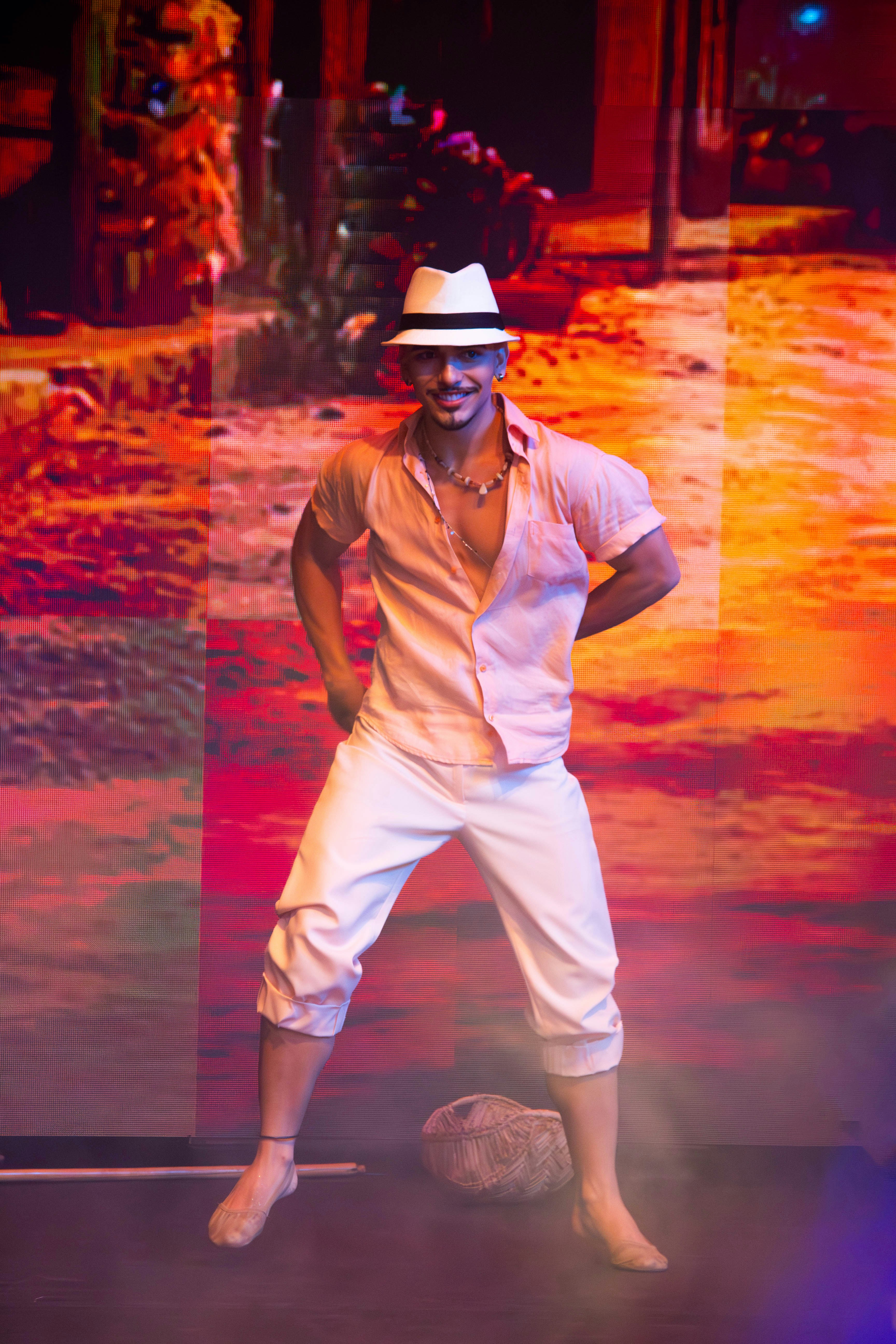 Portrait of a Dapper Performer Beneath Sunset-Hued Stage Lights